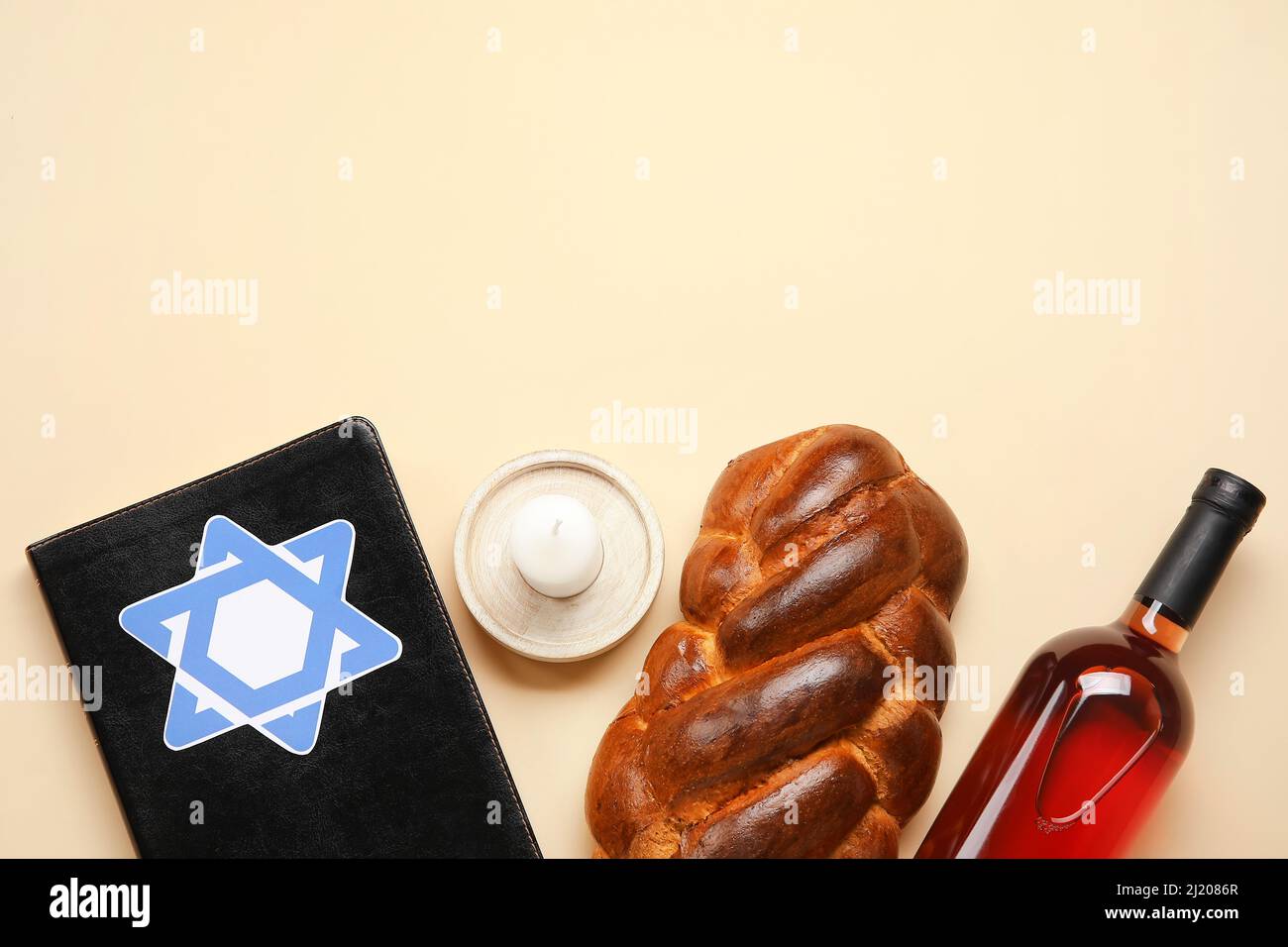 Torah with traditional challah bread, bottle of wine and candle on ...