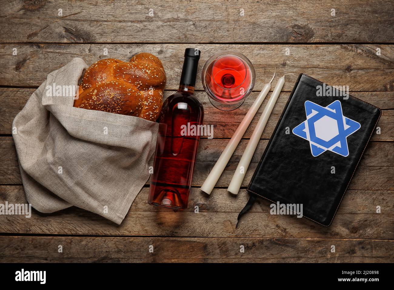 Torah with traditional challah bread, wine and candles on wooden ...
