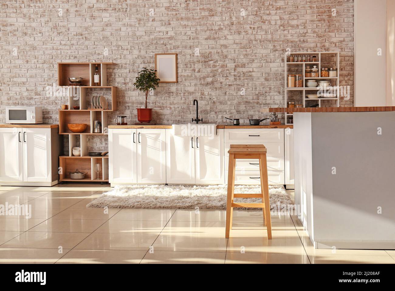 Interior of modern kitchen with white counters, shelving units and ...