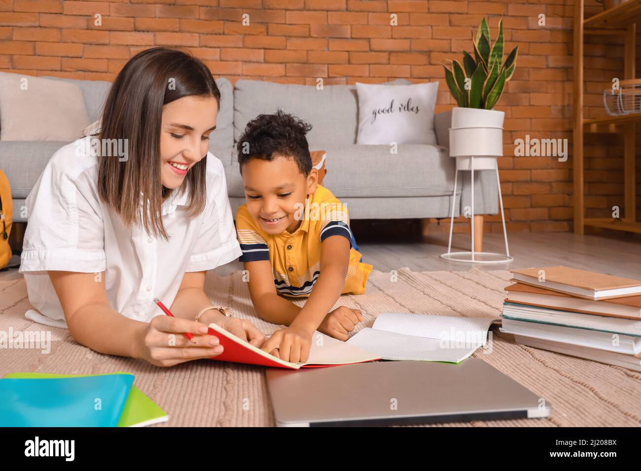 Little African-American boy studying with tutor at home Stock Photo - Alamy