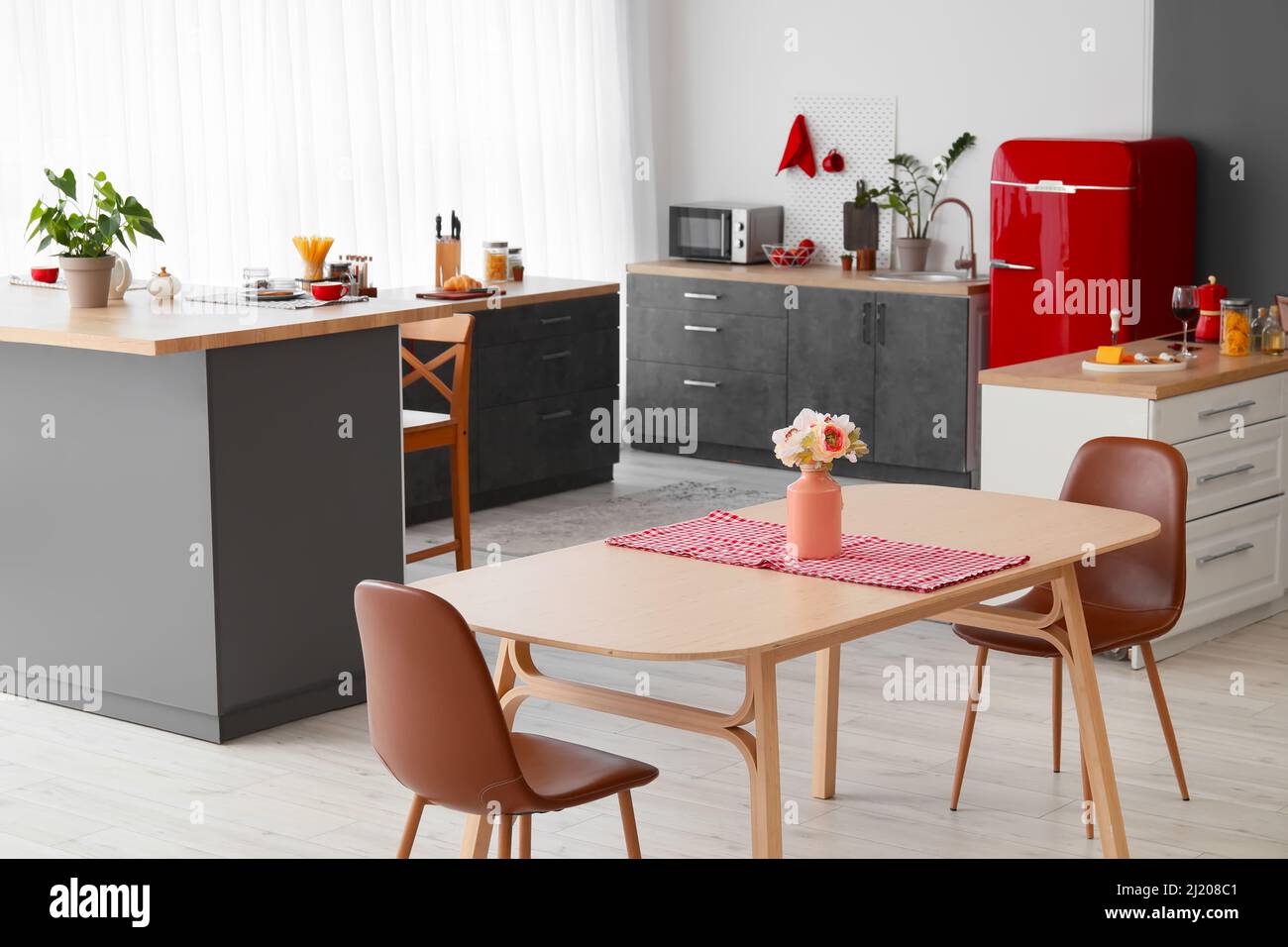 Interior of modern kitchen with red fridge, counters and pegboard Stock ...
