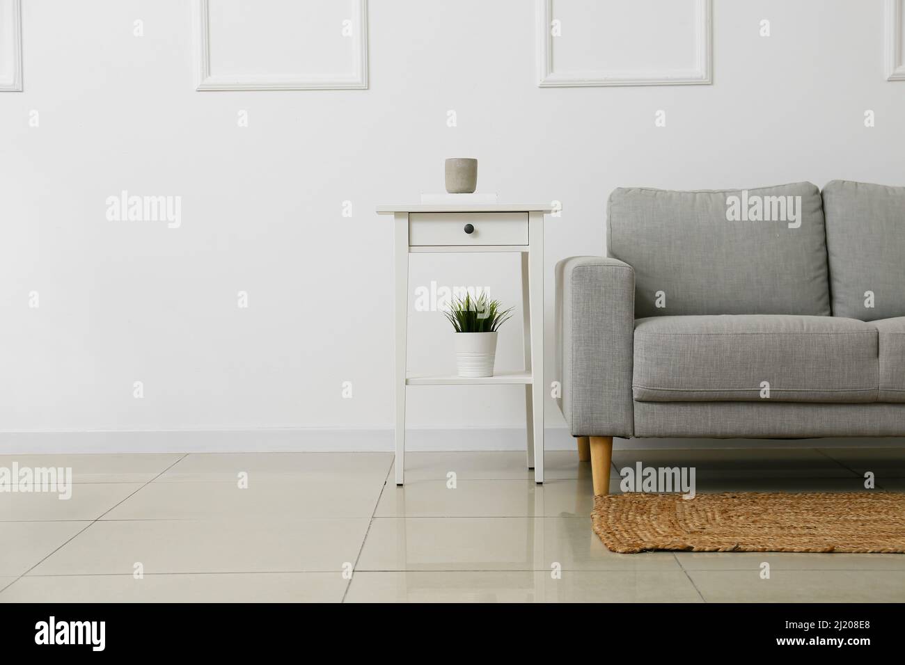 Interior of modern light living room with stylish sofa Stock Photo - Alamy