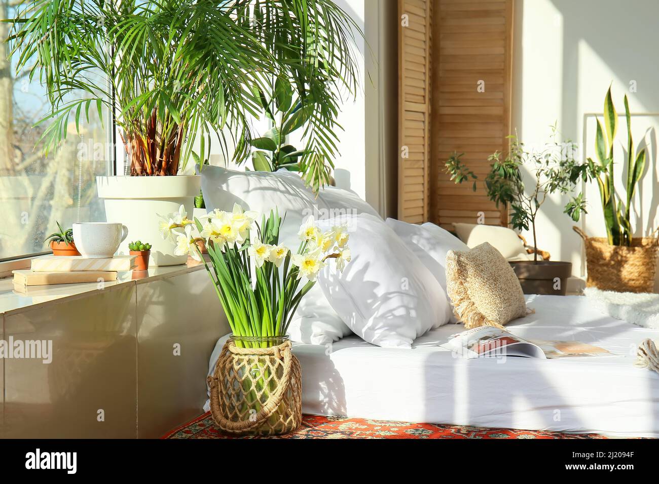 Interior of cozy bedroom with houseplants and flowers in vase Stock ...