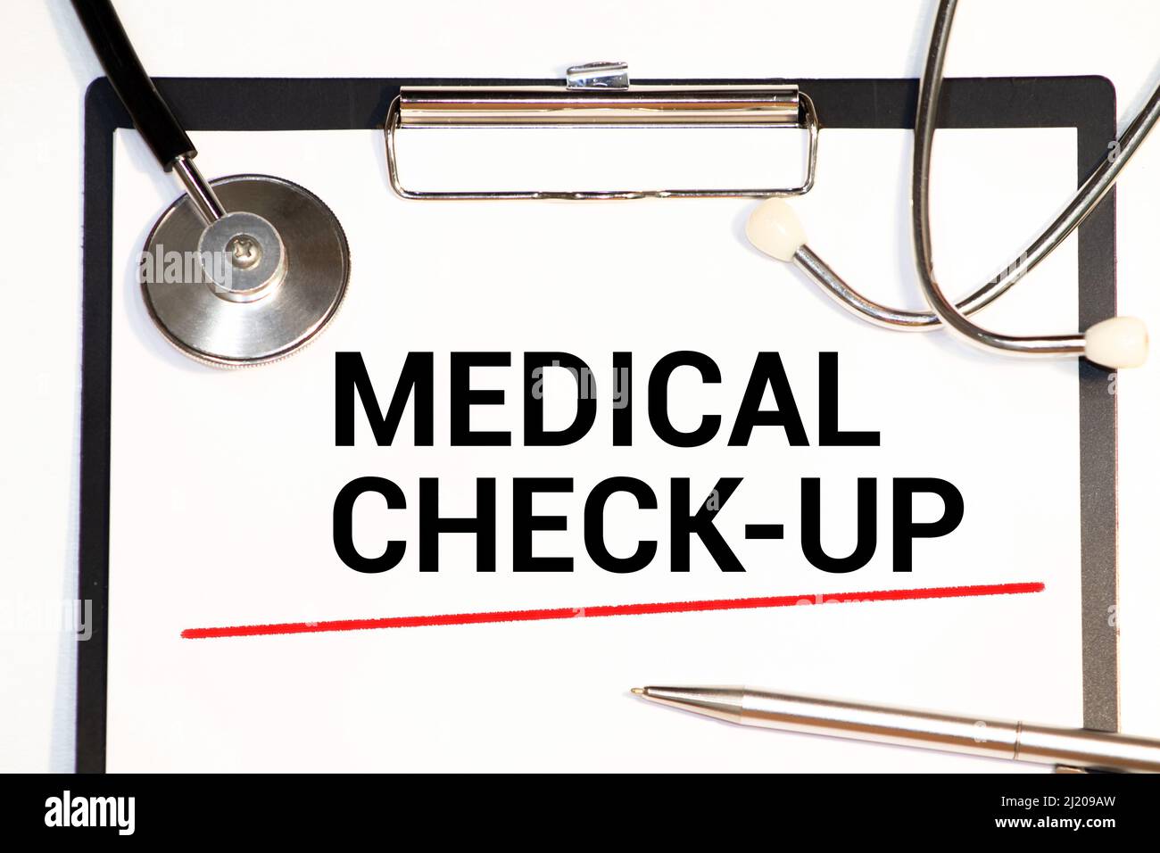 Black stethoscope on a dark surface with MEDICAL CHECK UP wordings ...