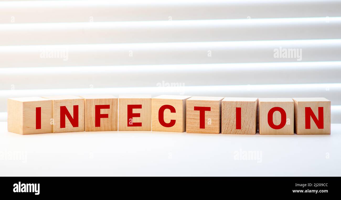 INFECTION text made in building wood blocks Stock Photo - Alamy