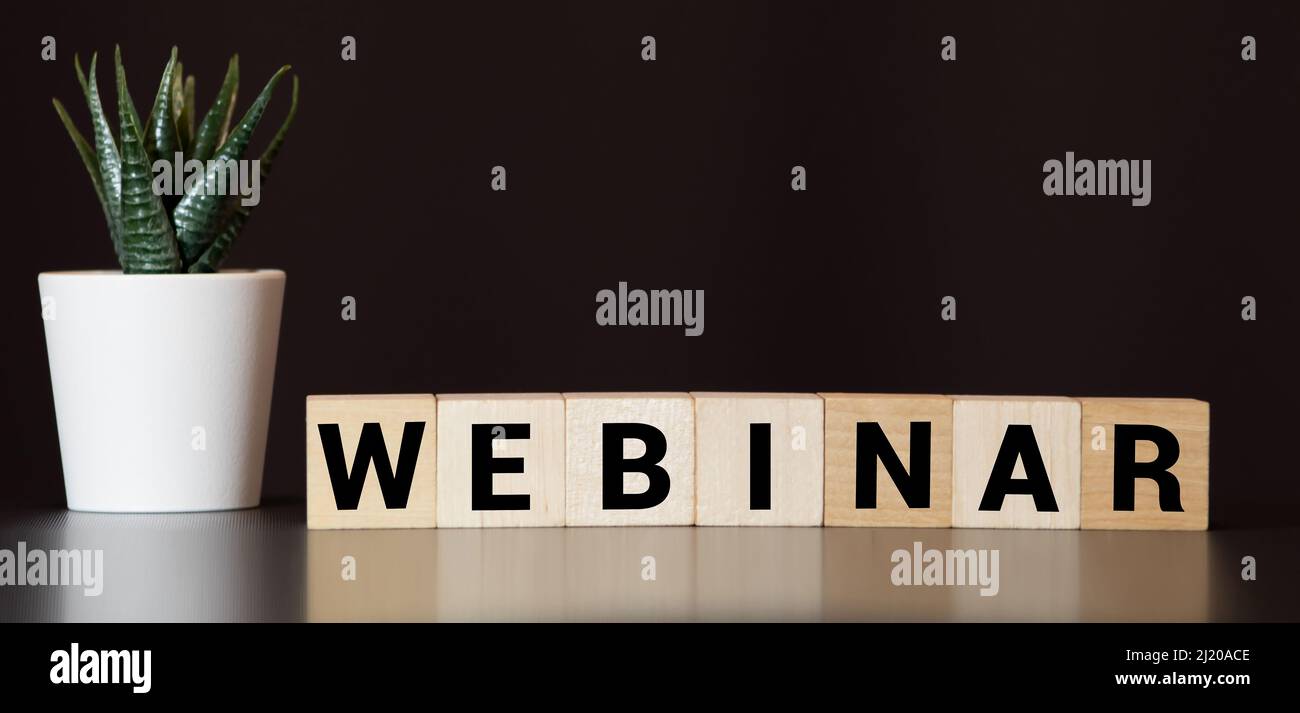 WEBINAR word written on wood block. WEBINAR text on wooden table for ...