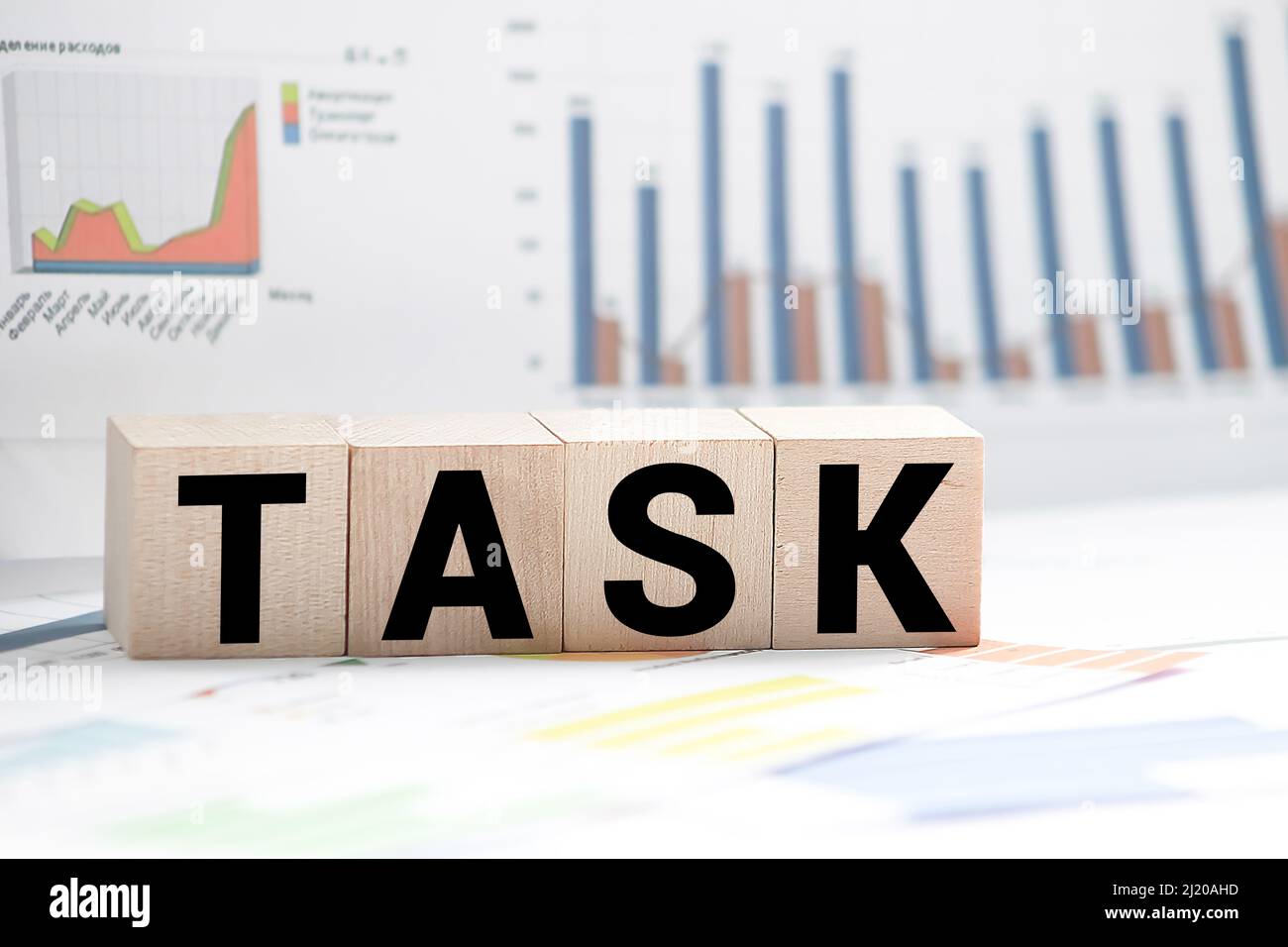 Businesswoman hand holding wooden cube block with TASK business word on ...