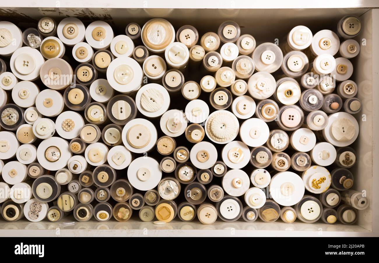 Buttons in tubes on store shelves Stock Photo - Alamy