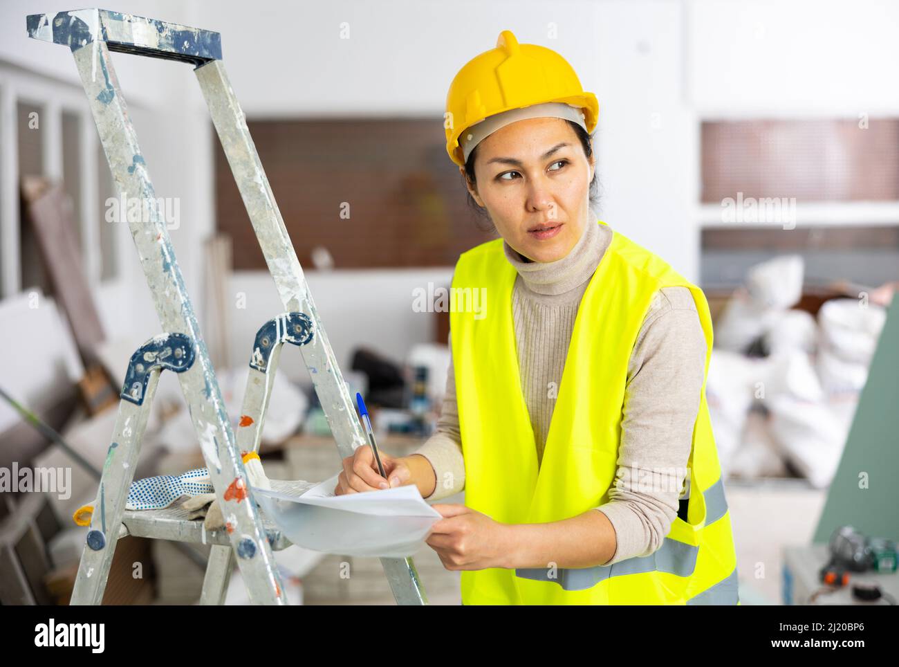 Woman signs an act of acceptance of completed work Stock Photo - Alamy