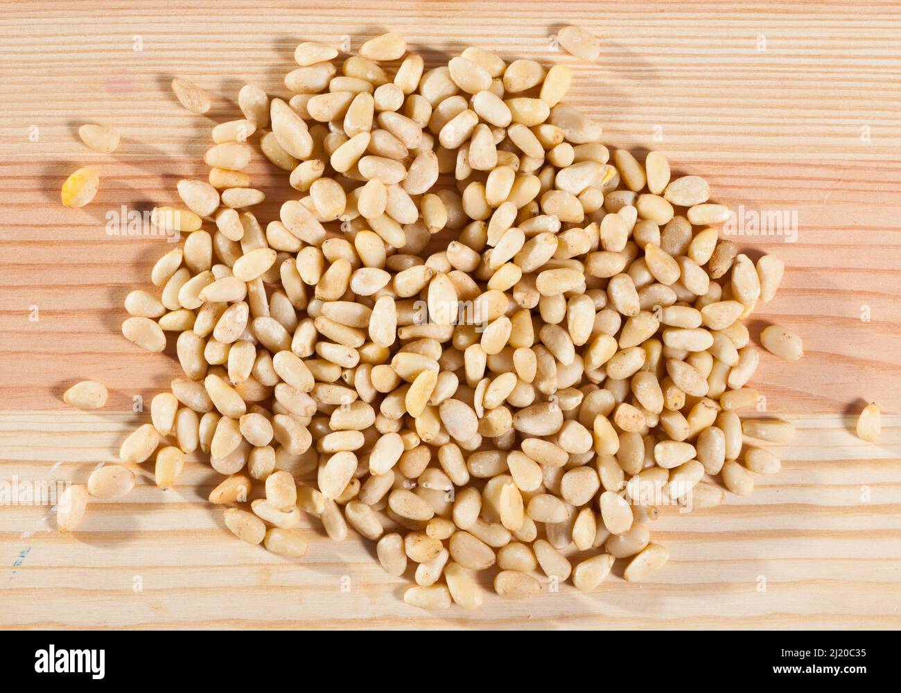 Photo of mix raw pine nut on the wooden desk Stock Photo - Alamy