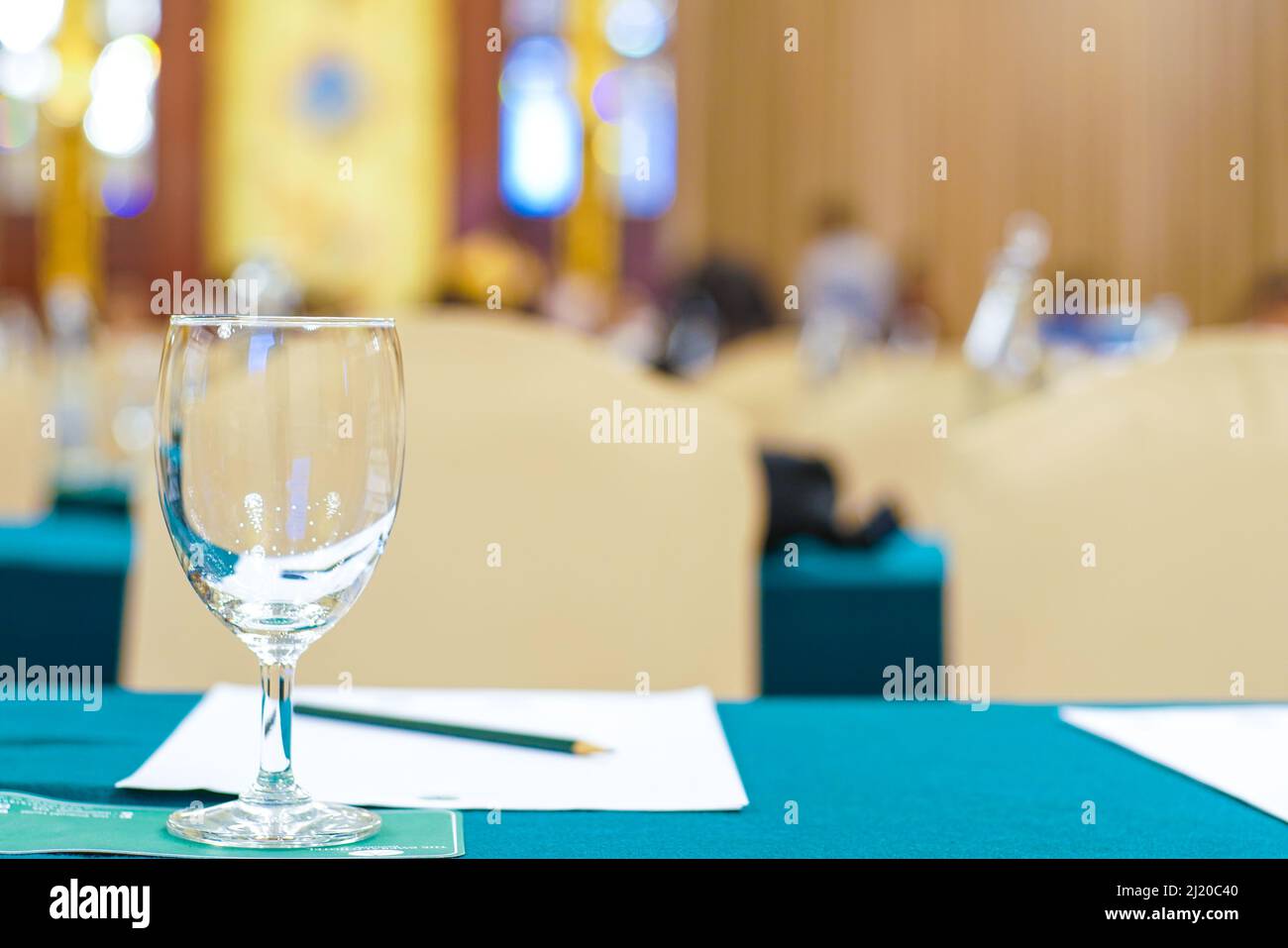 Drinkking water in wine glass on table of meeting room blurred ...