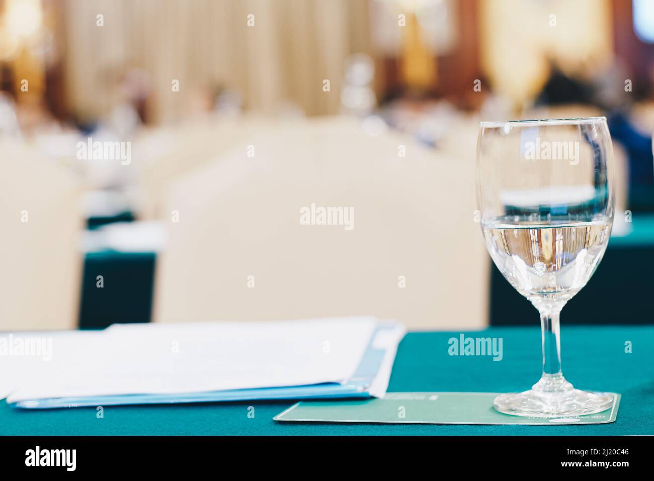 Drinkking water in wine glass on table of meeting room blurred ...