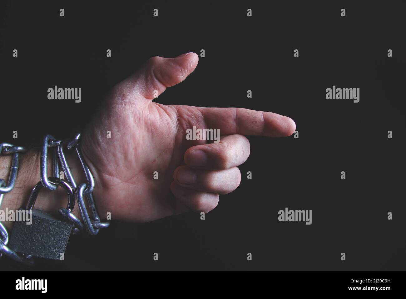 Chain and lock on hand. Arrest of a criminal. Handcuffs on the prisoner ...