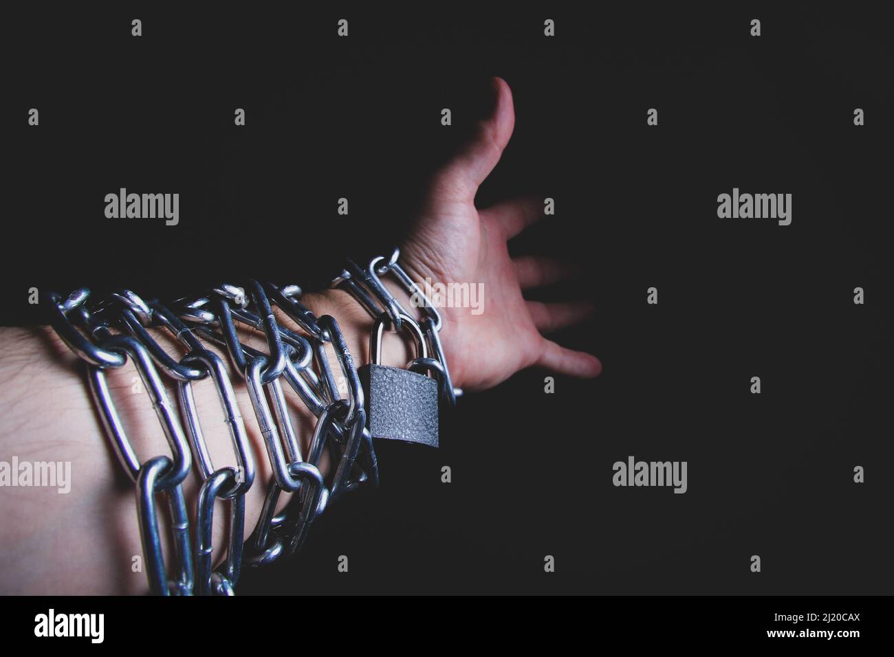 Chain and lock on hand. Arrest of a criminal. Handcuffs on the prisoner ...