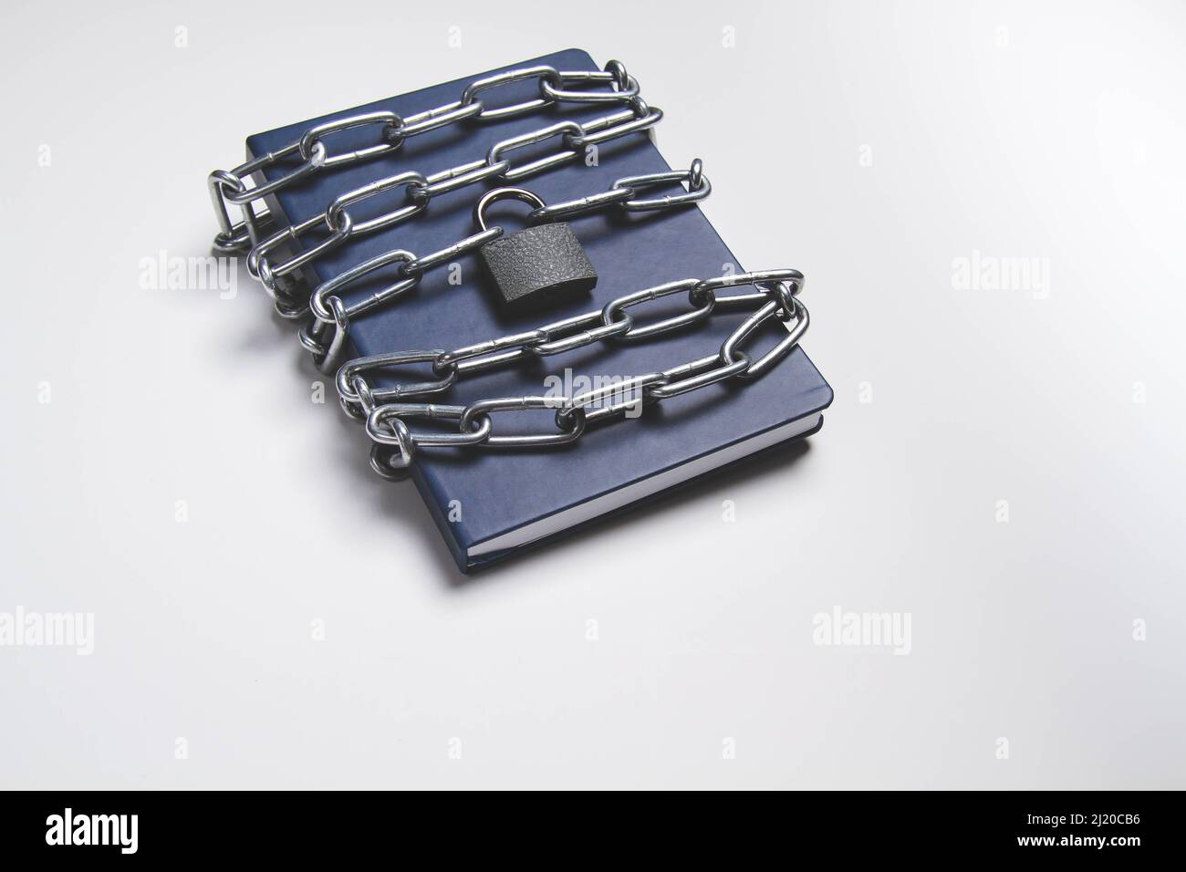 The book is locked under lock and key on a white background. Secret ...