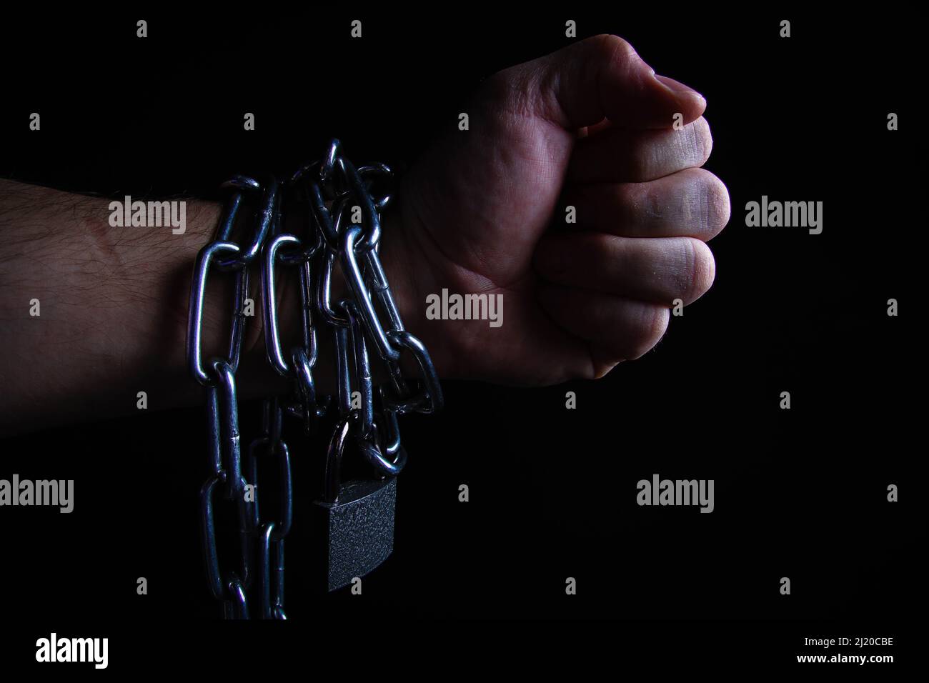 Chain and lock on hand. Arrest of a criminal. Handcuffs on the prisoner ...