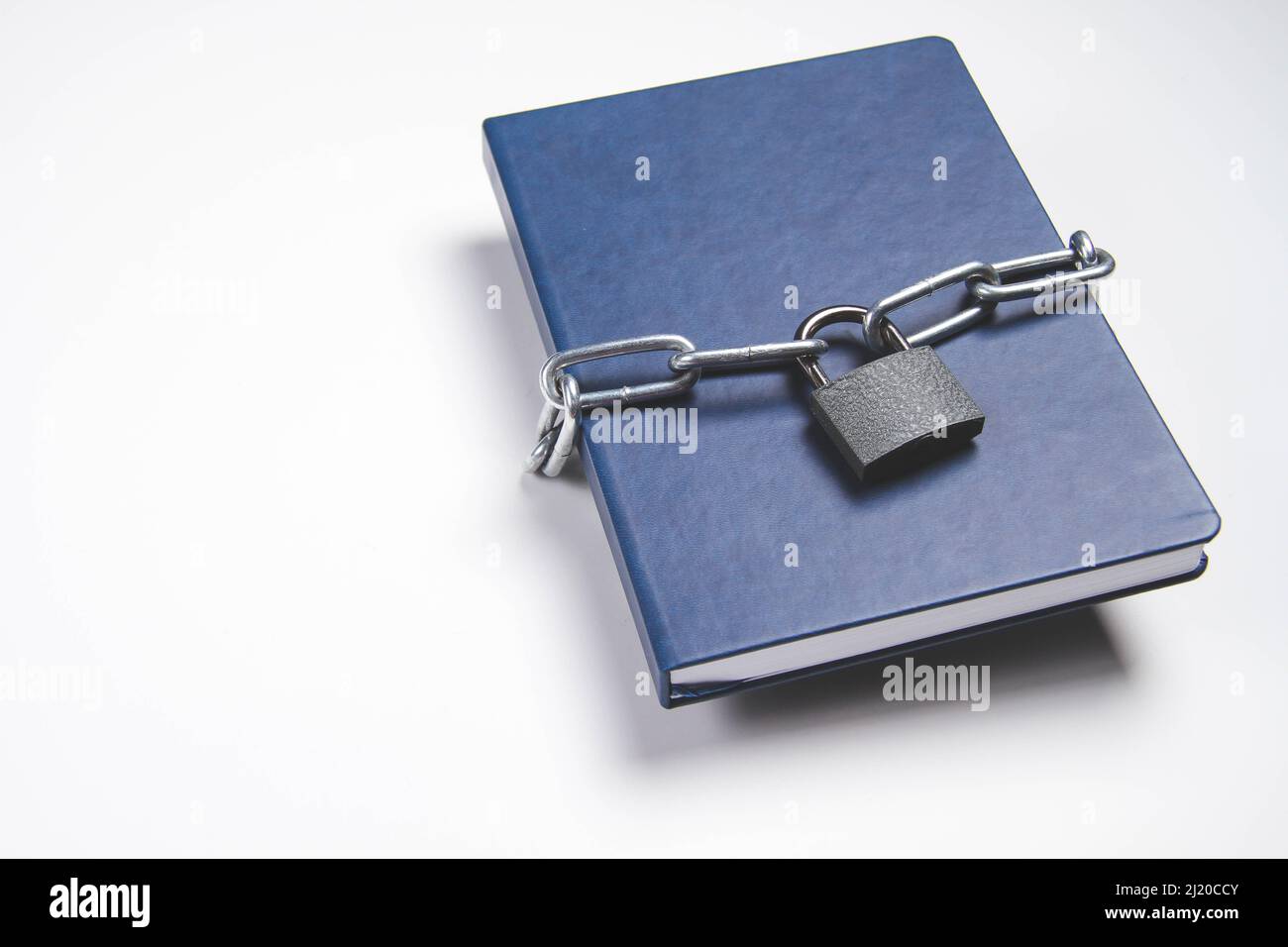 The book is locked under lock and key on a white background. Secret ...