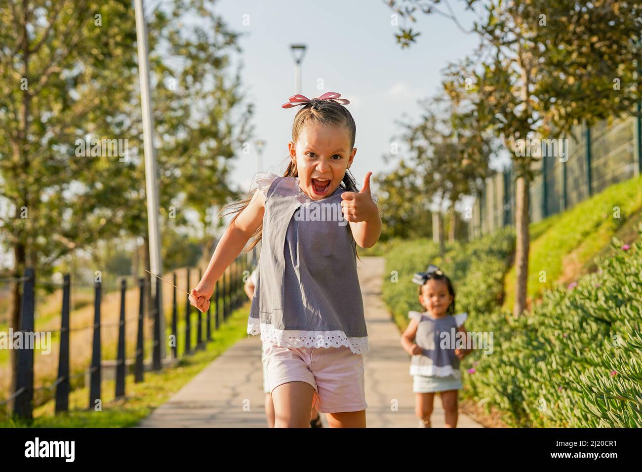 Excited happy girl running in the park enjoying Stock Photo - Alamy