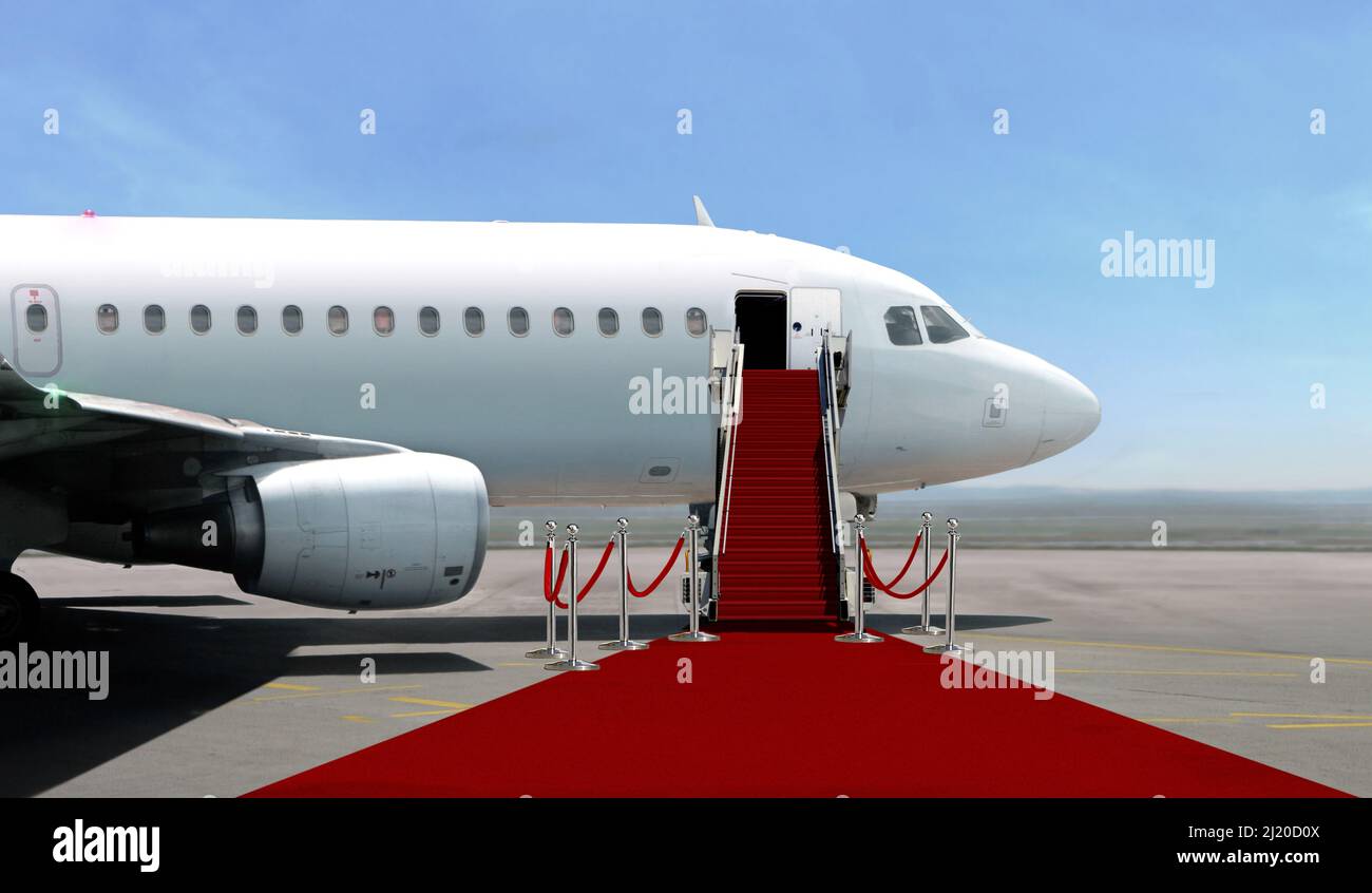 Airplane with red carpet on airport taxiway under bright blue sky Stock ...