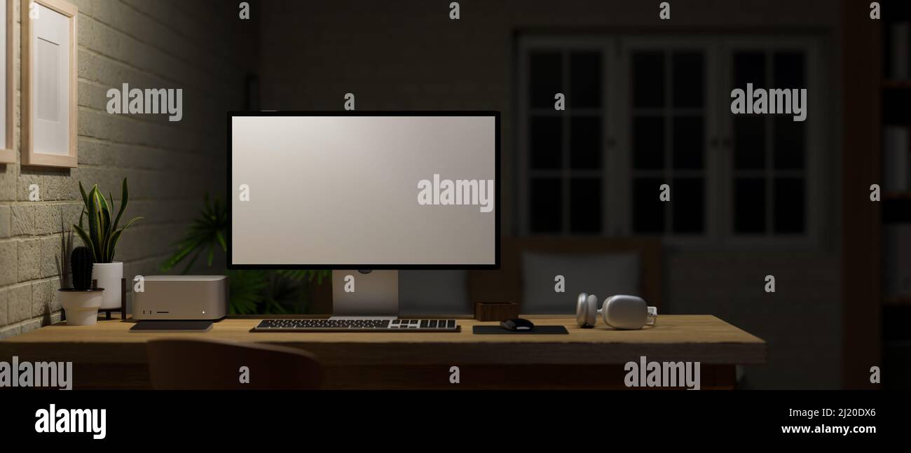 Modern dark office workspace at night with pc computer white screen ...