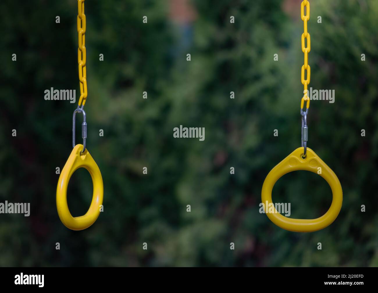 Two yellow handles on playground set outdoors in the sunshine Stock ...