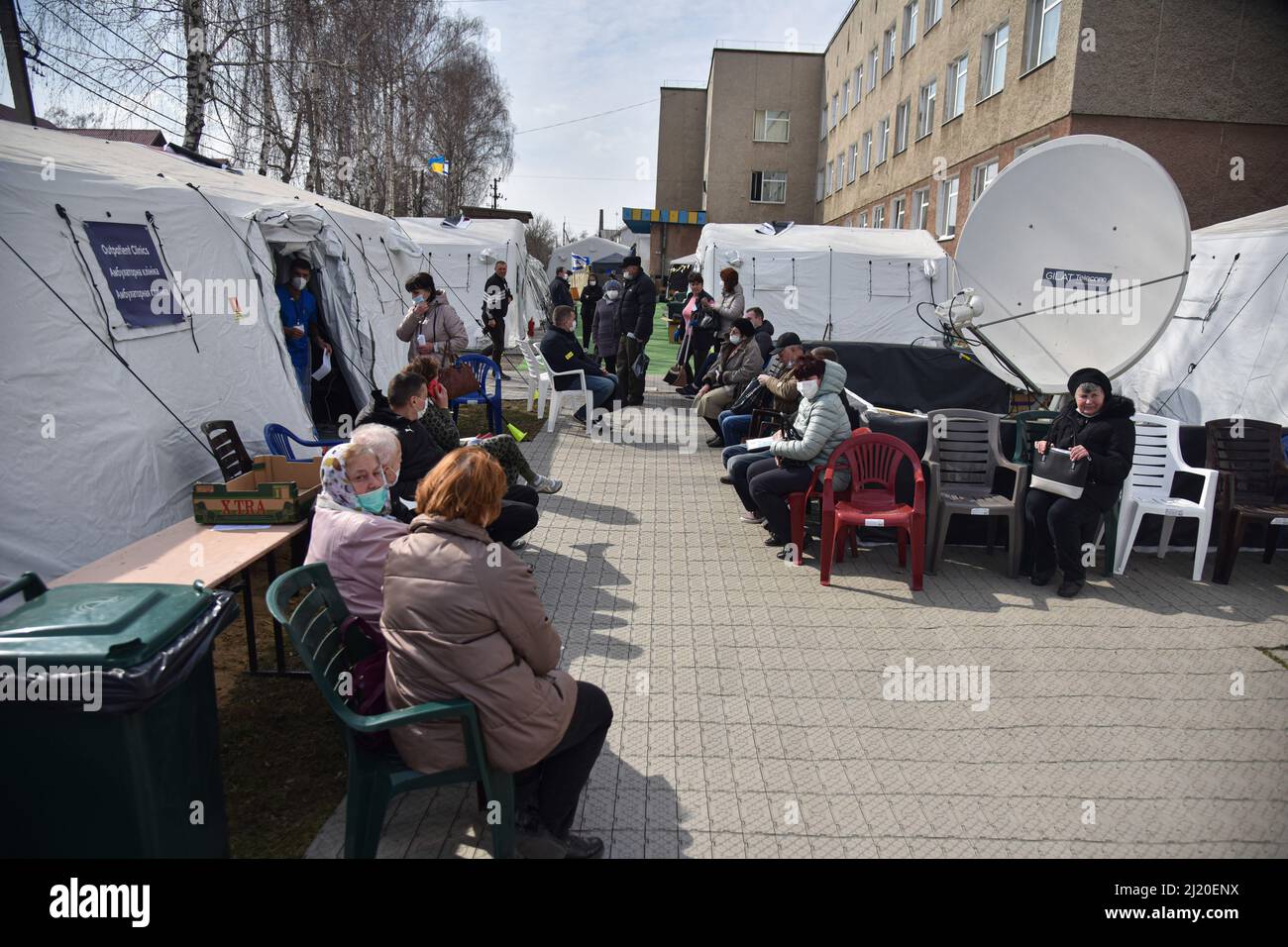 Mostyska, Ukraine. 26th Mar, 2022. People are seen waiting in the line ...