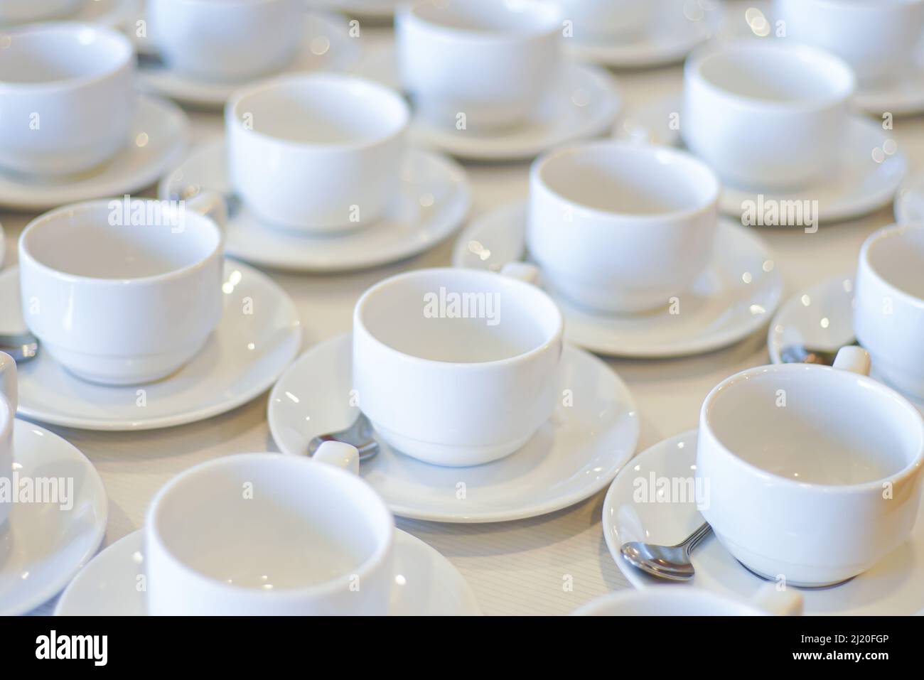 Hot coffee cup row with spoon in hotel seminar room Stock Photo - Alamy