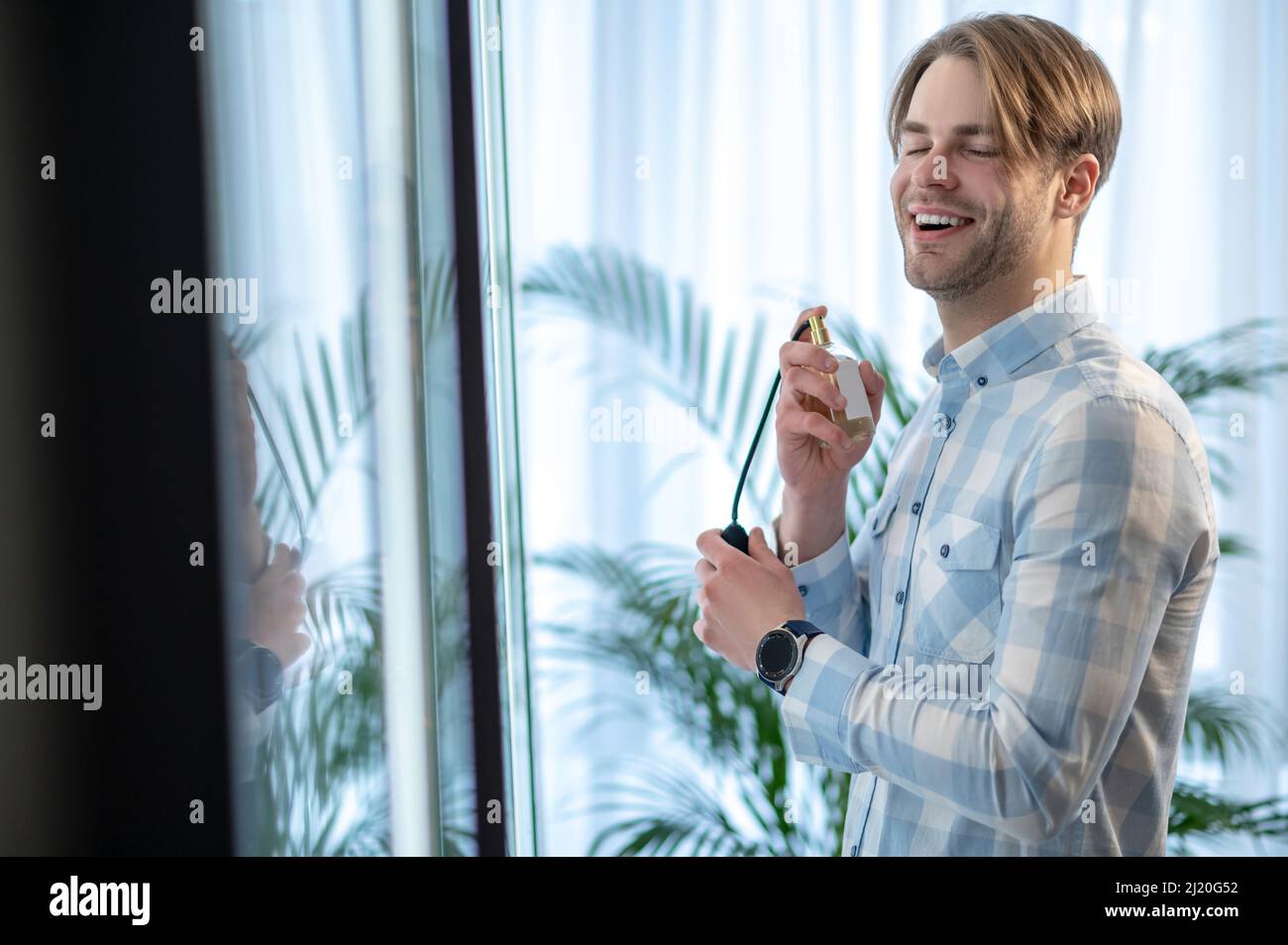 Man spraying perfume hi-res stock photography and images - Alamy