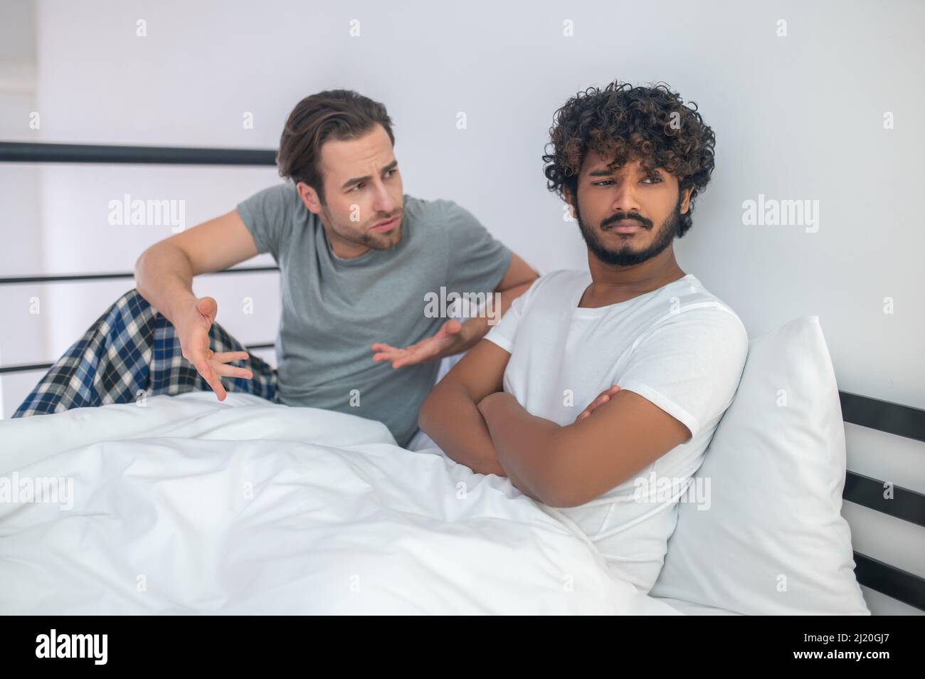 Displeased guy arguing with his male partner Stock Photo - Alamy