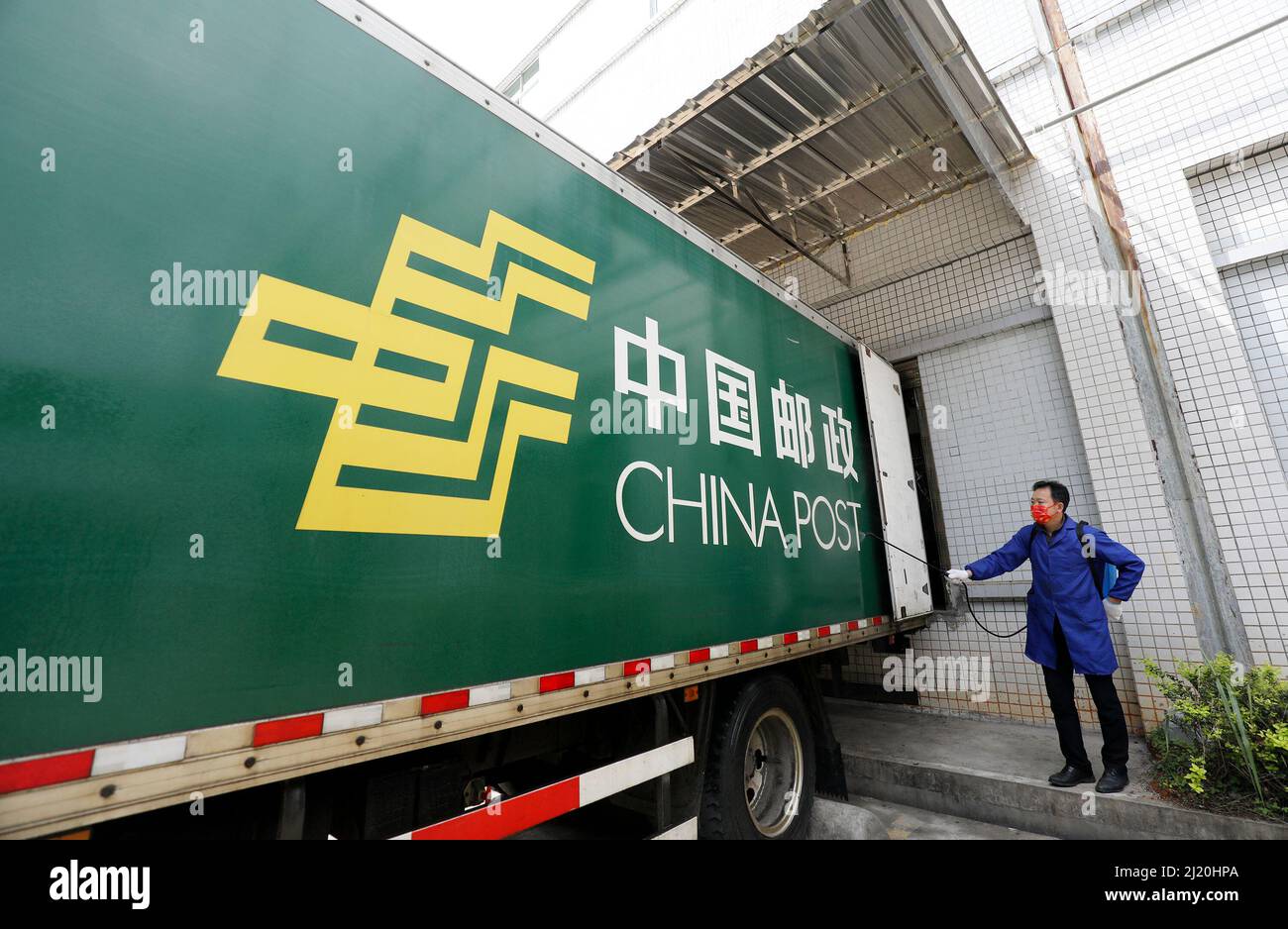 CHENZHOU, CHINA - MARCH 28, 2022 - A staff member disinfects a postal ...
