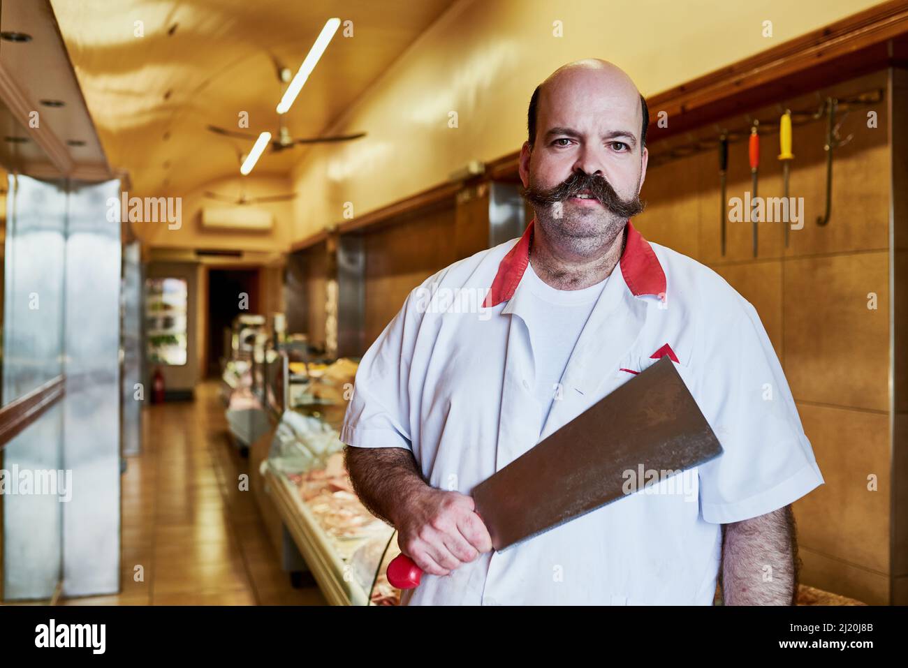 Work just wouldnt be the same without my knife. Shot of a butcher at ...