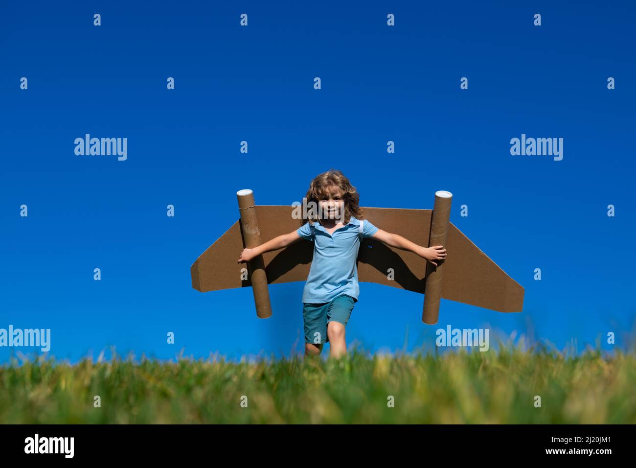 Kid with jet pack superhero. Child pilot against summer sky background ...