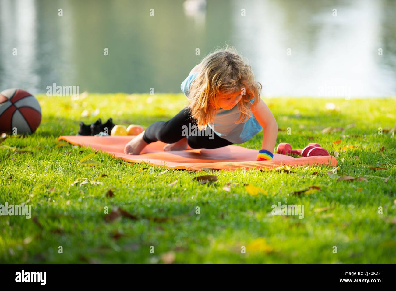 Kid pushing up. Boy doing push up exercise outdoors. Healthy lifestyle ...