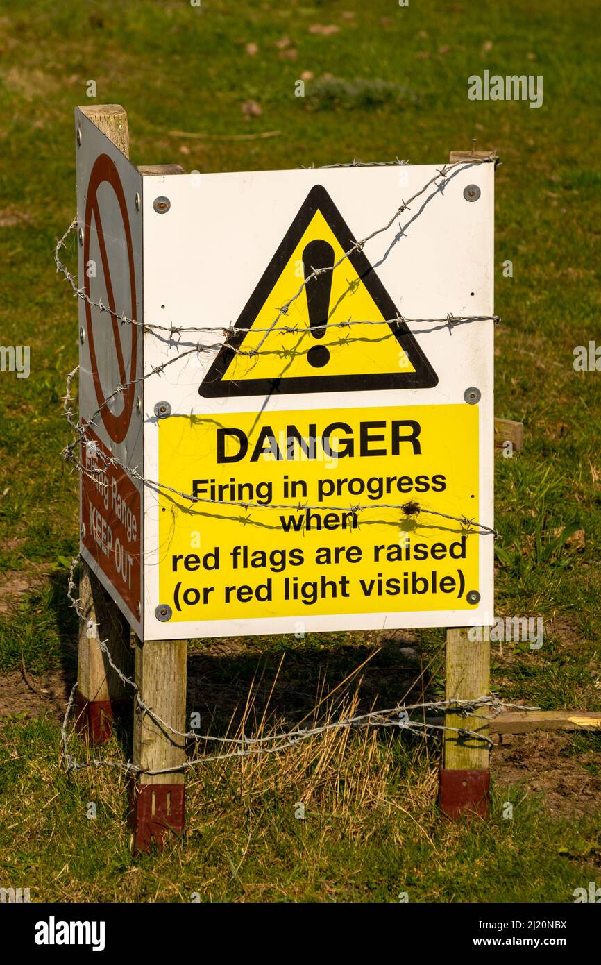 Firing range warning signs wrapped in barbed wire Stock Photo - Alamy