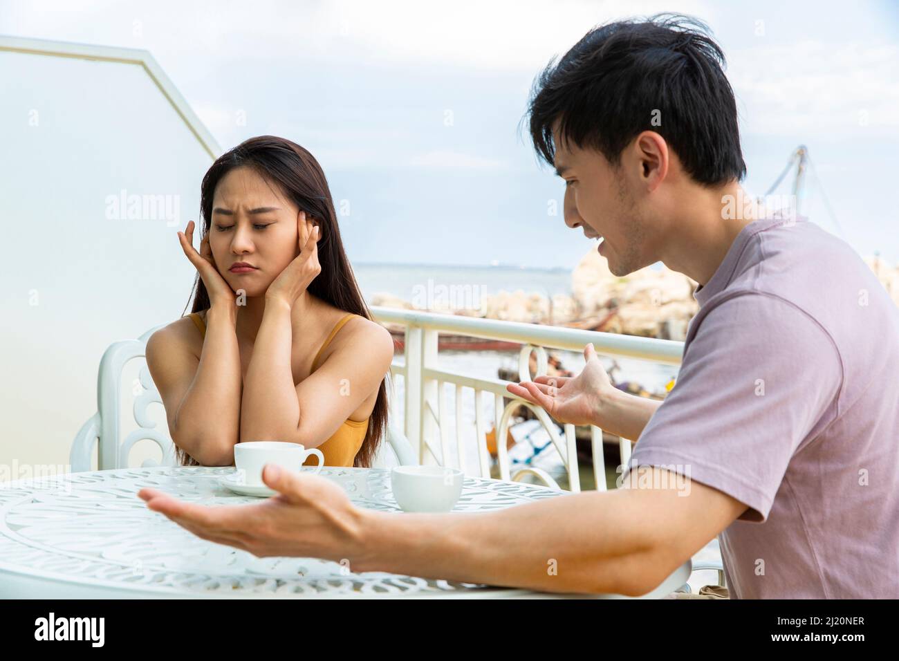 Two lovers arguing at a beachfront restaurant - stock photo Stock Photo ...