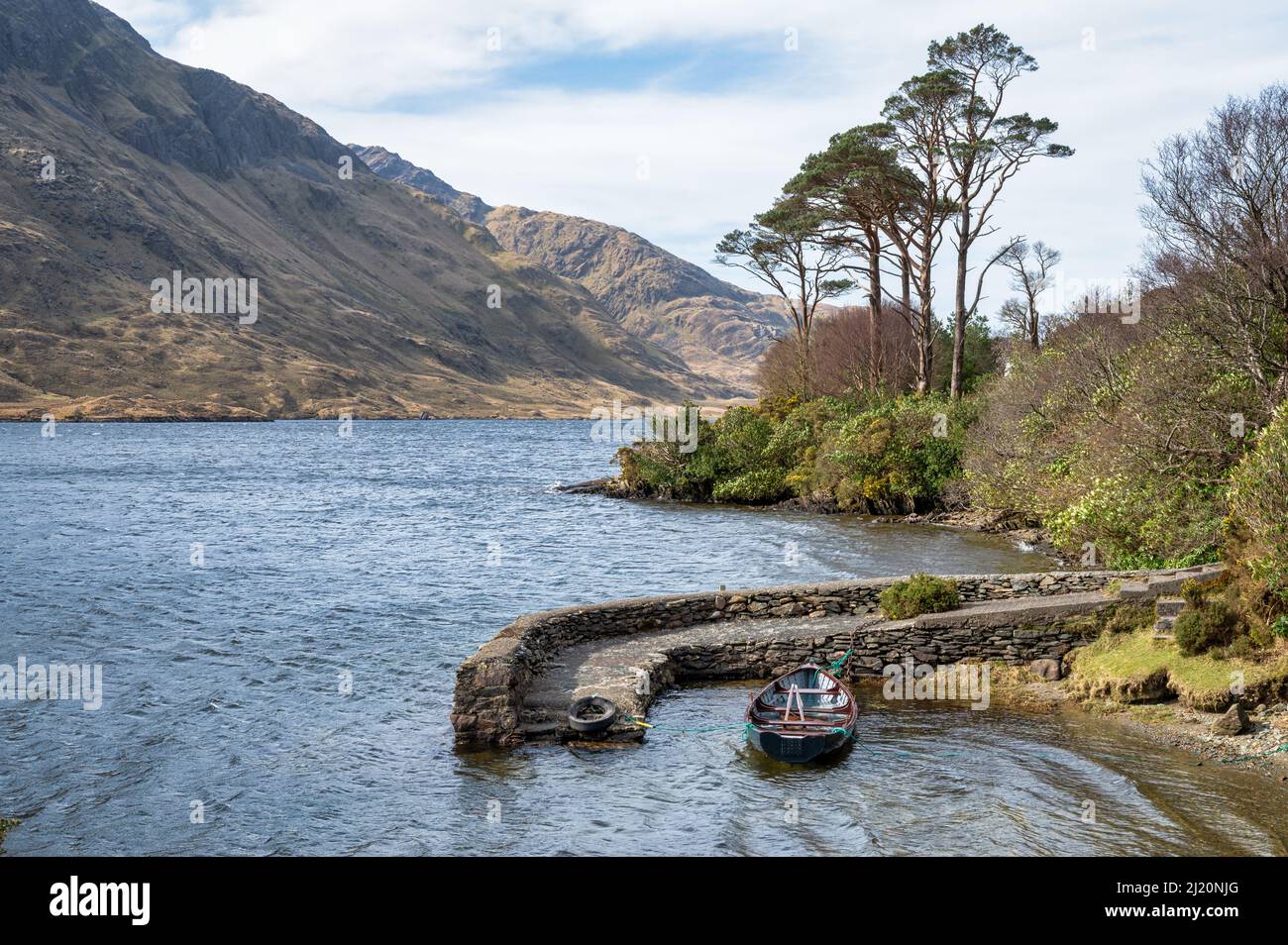 A small stone dock on Doo lough in the mountains of County Mayo Ireland ...