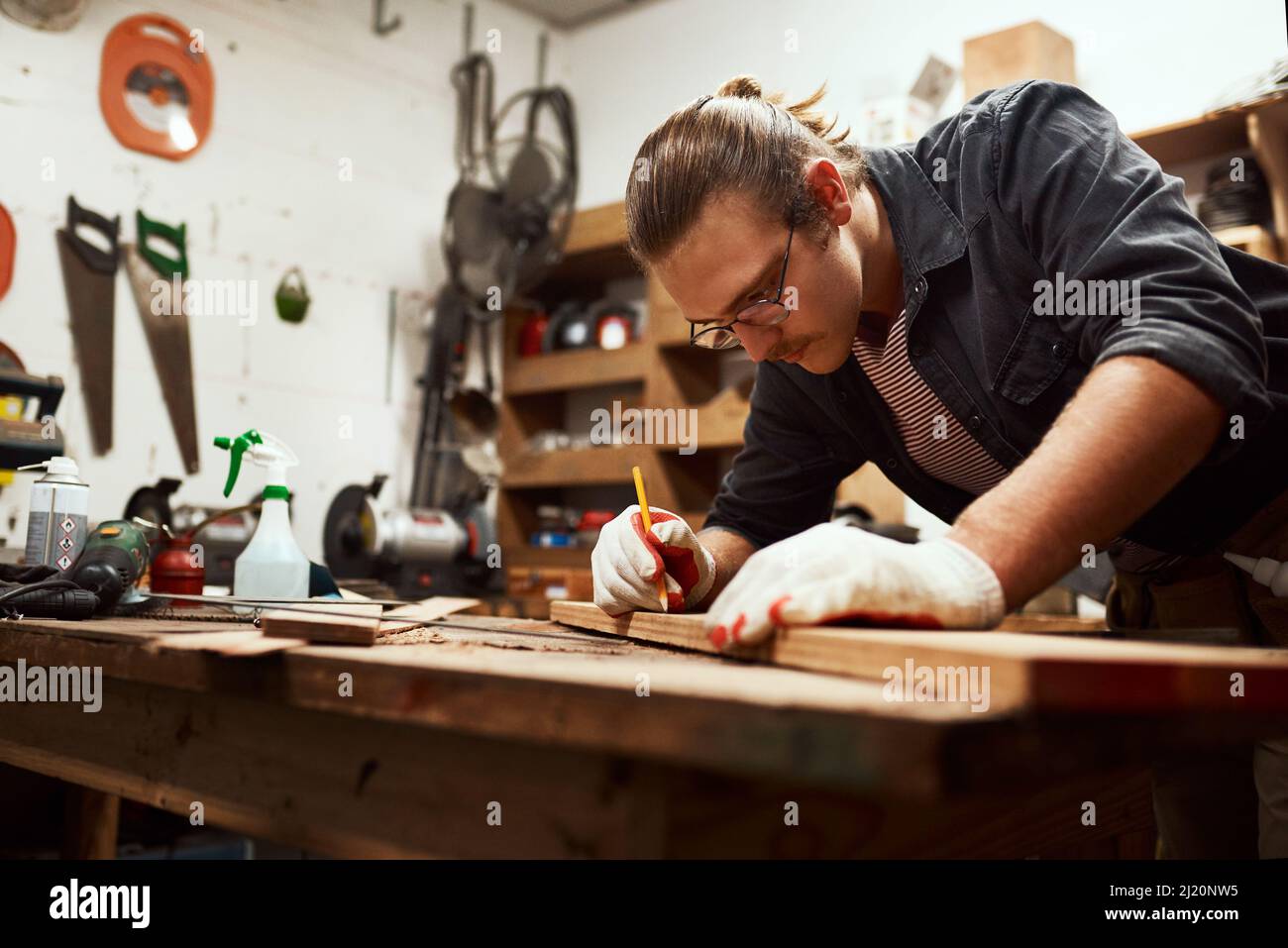 Concentration levels high. Cropped shot of a focused young carpenter ...
