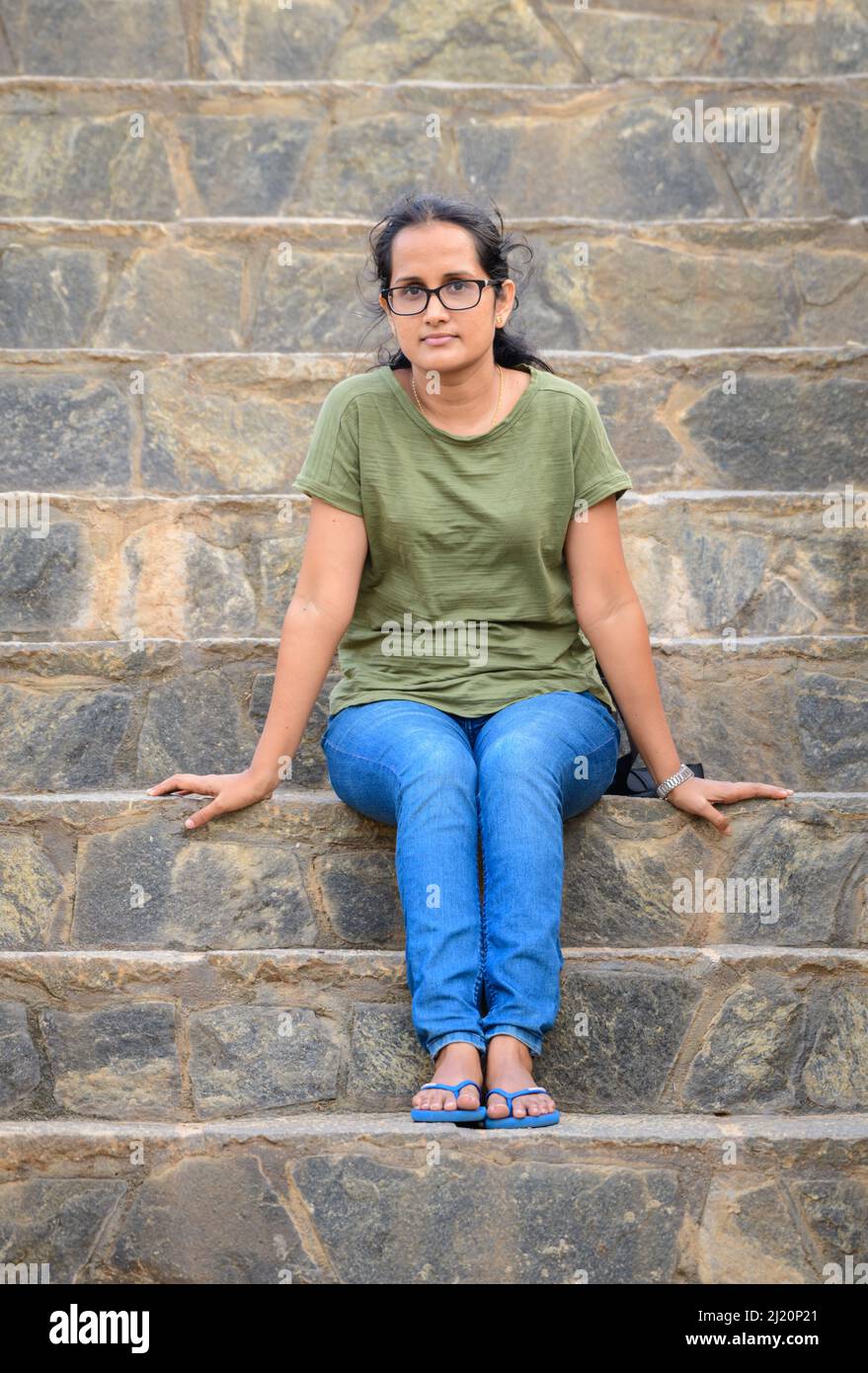 Cute girl sitting on the stone stairs in the Galle fort Stock Photo - Alamy