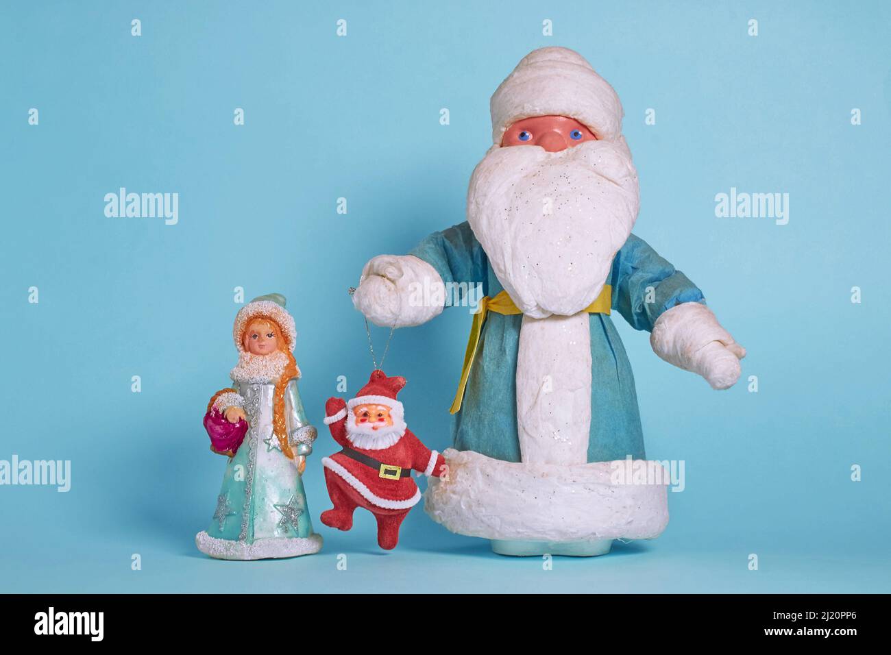 Toy Russian Snow Maiden and Ded Moroz holds christmas tree toy Santa ...