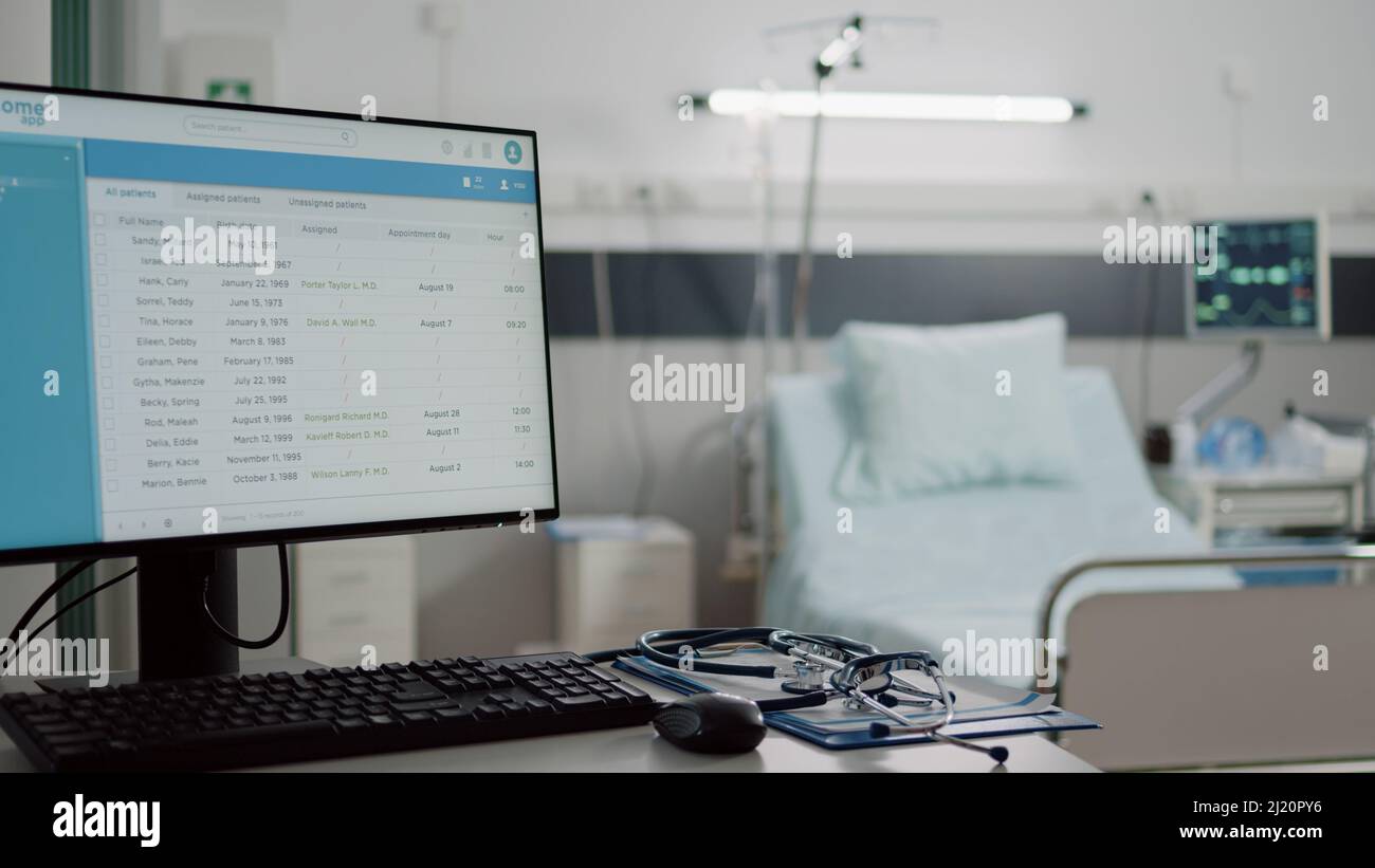 Close up of desk with computer and medical tools in empty hospital ward ...