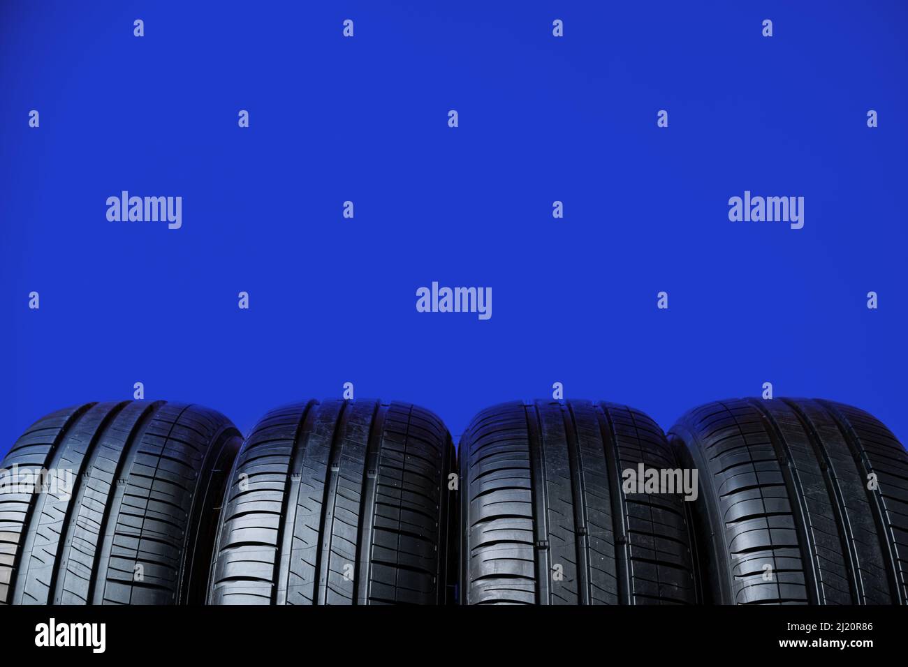 Group of tires on a blue background Stock Photo - Alamy