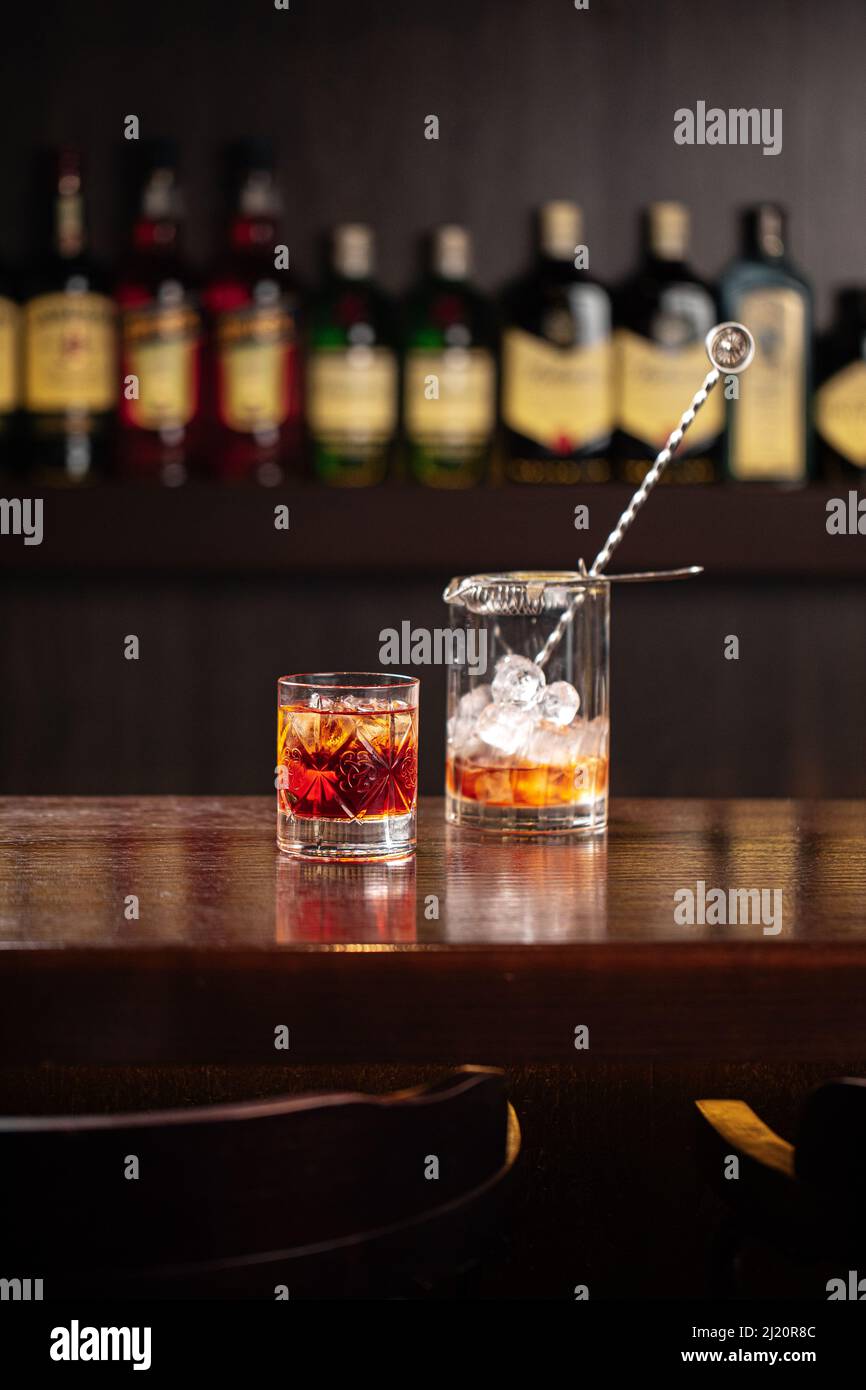 Crystal glass of classic negroni cocktail with ice Stock Photo - Alamy