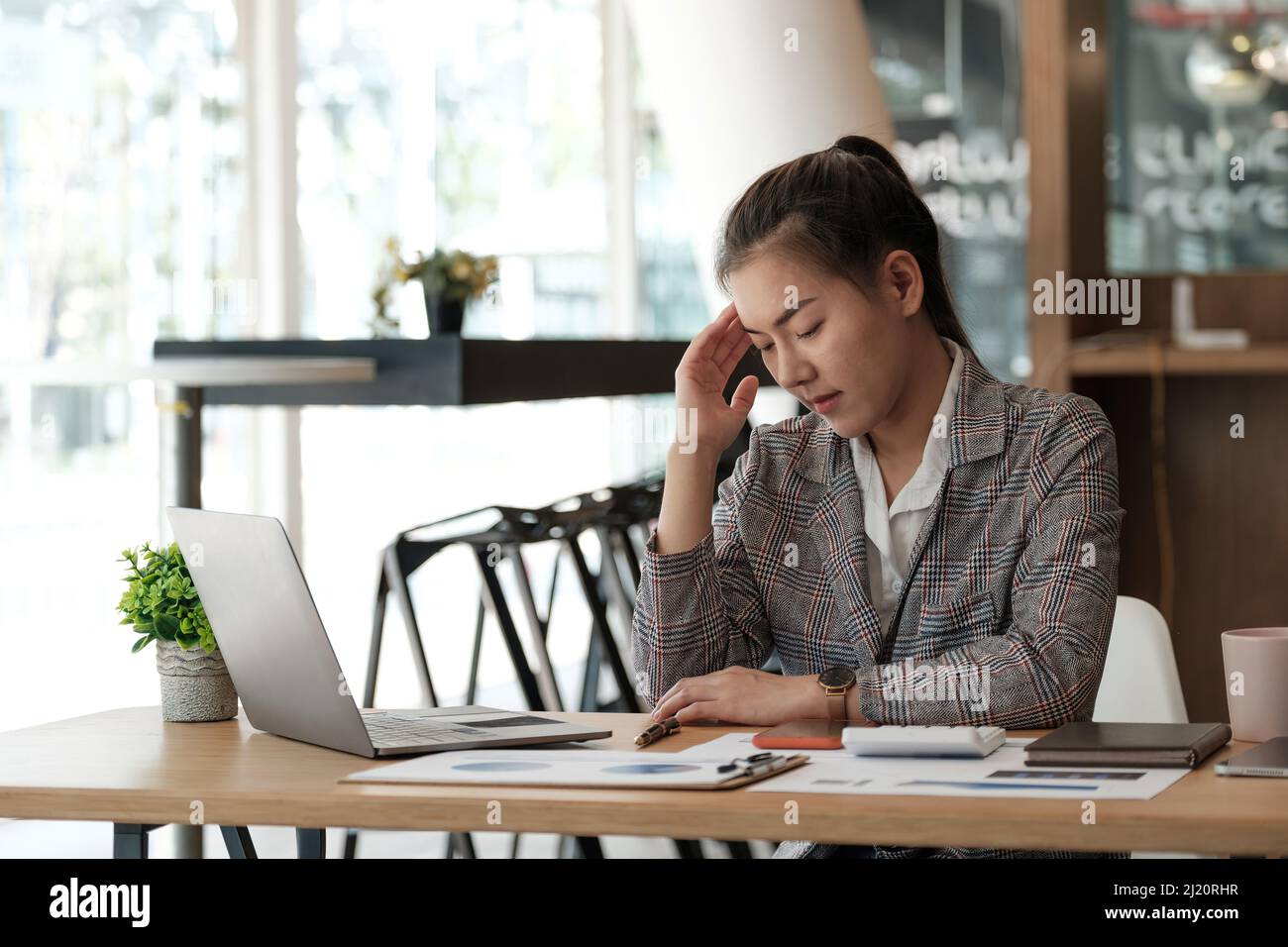 Stressed Business Woman Working From Home On Laptop Looking Worried