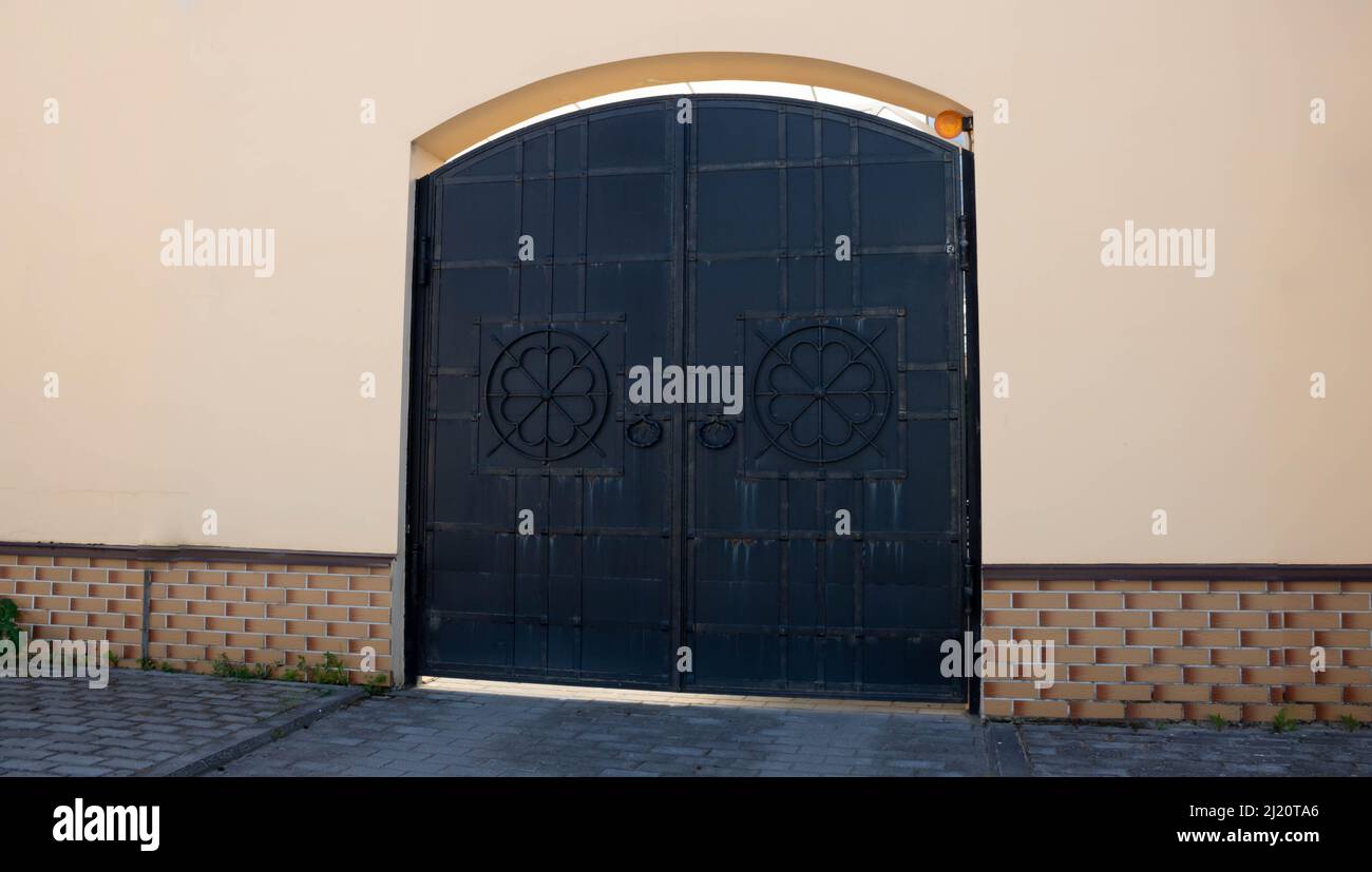 New forged metal double gates for entry of cars into the yard closed ...