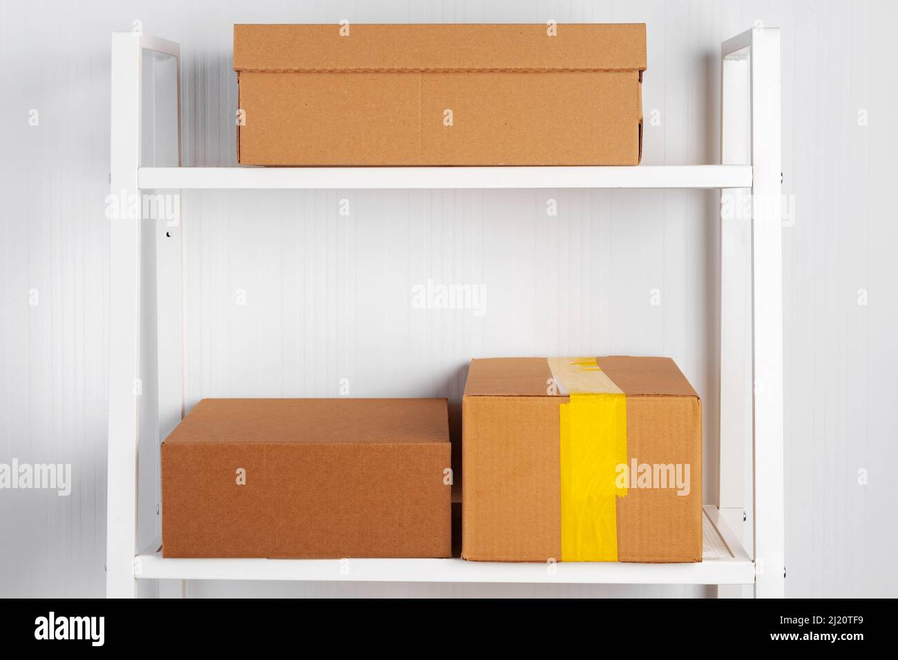 Stack of cardboard package boxes on wooden rack Stock Photo - Alamy