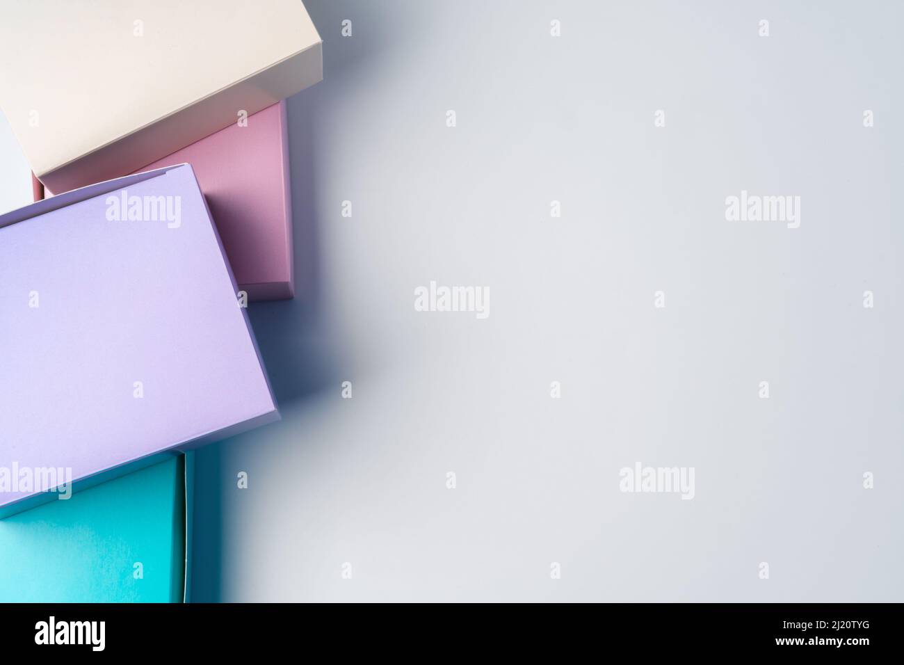 Pile of colorful cardboard boxes on white background Stock Photo - Alamy