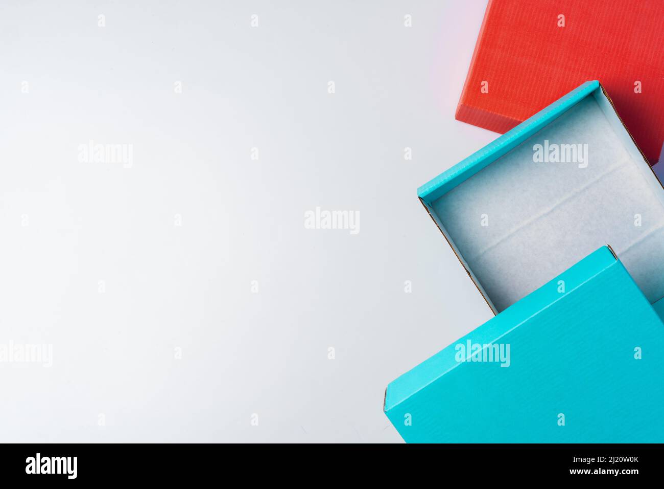 Pile of colorful cardboard boxes on white background Stock Photo - Alamy