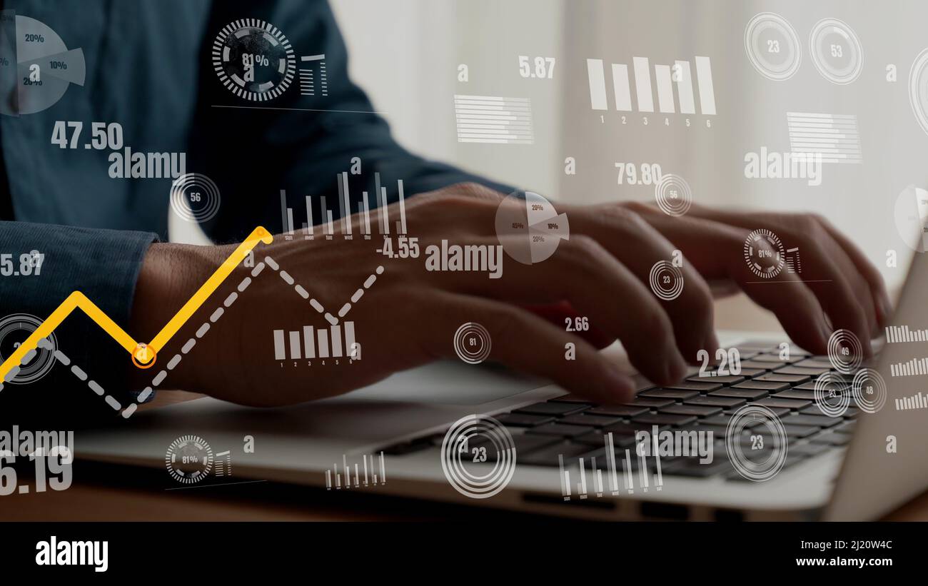 Businessman uses capable laptop computer to analyze business data ...