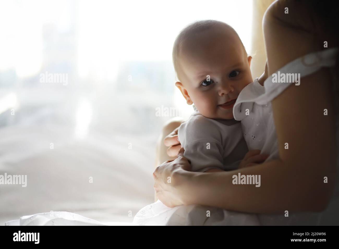 Maternity concept. A young mother feeds her little baby. First lure and ...