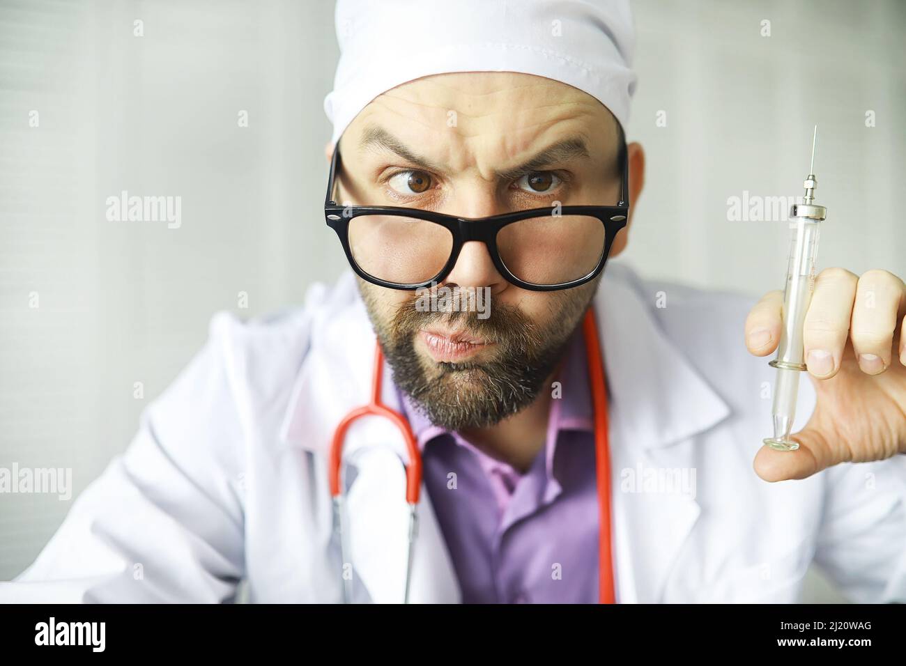 A cross-eyed bearded man is looking into the frame. Eye disease. The ...